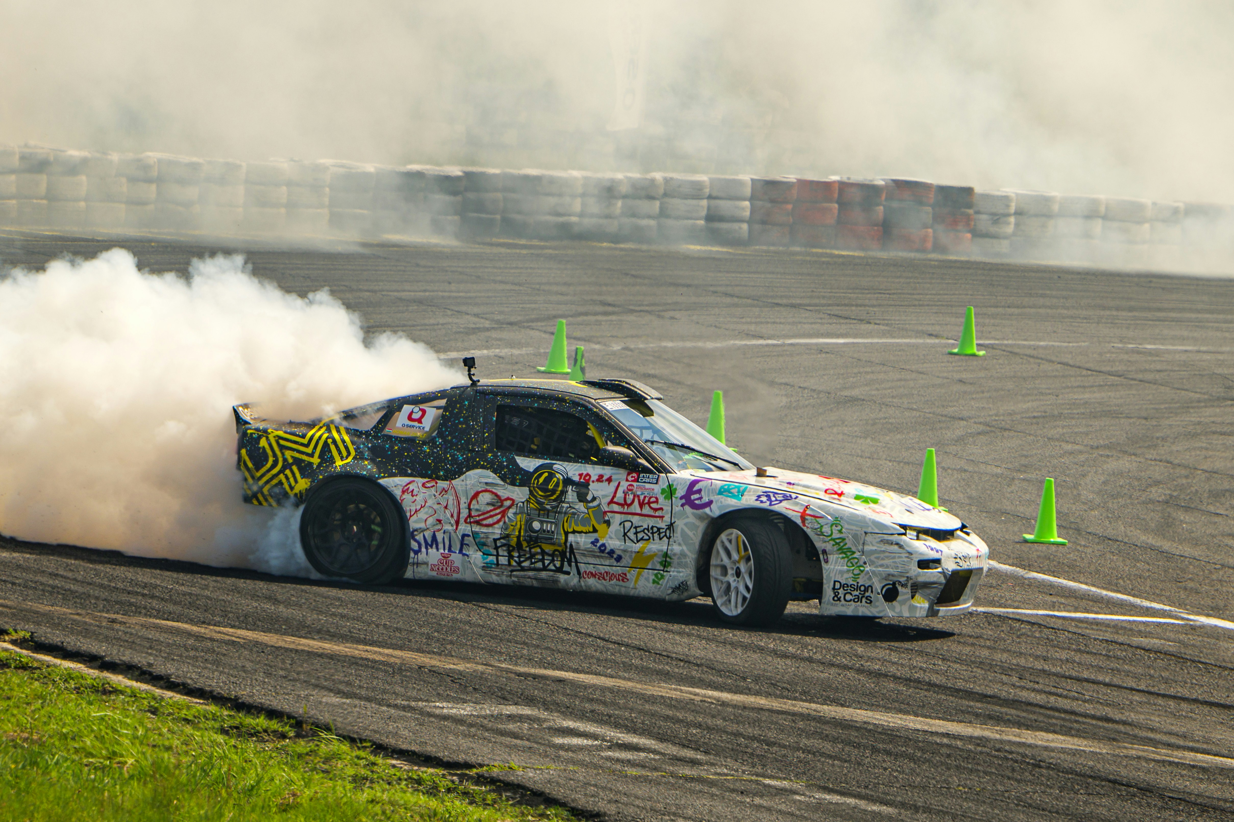 Graffiti-Wrapped Drift Car Orchestrates Smoke Through Neon Cones