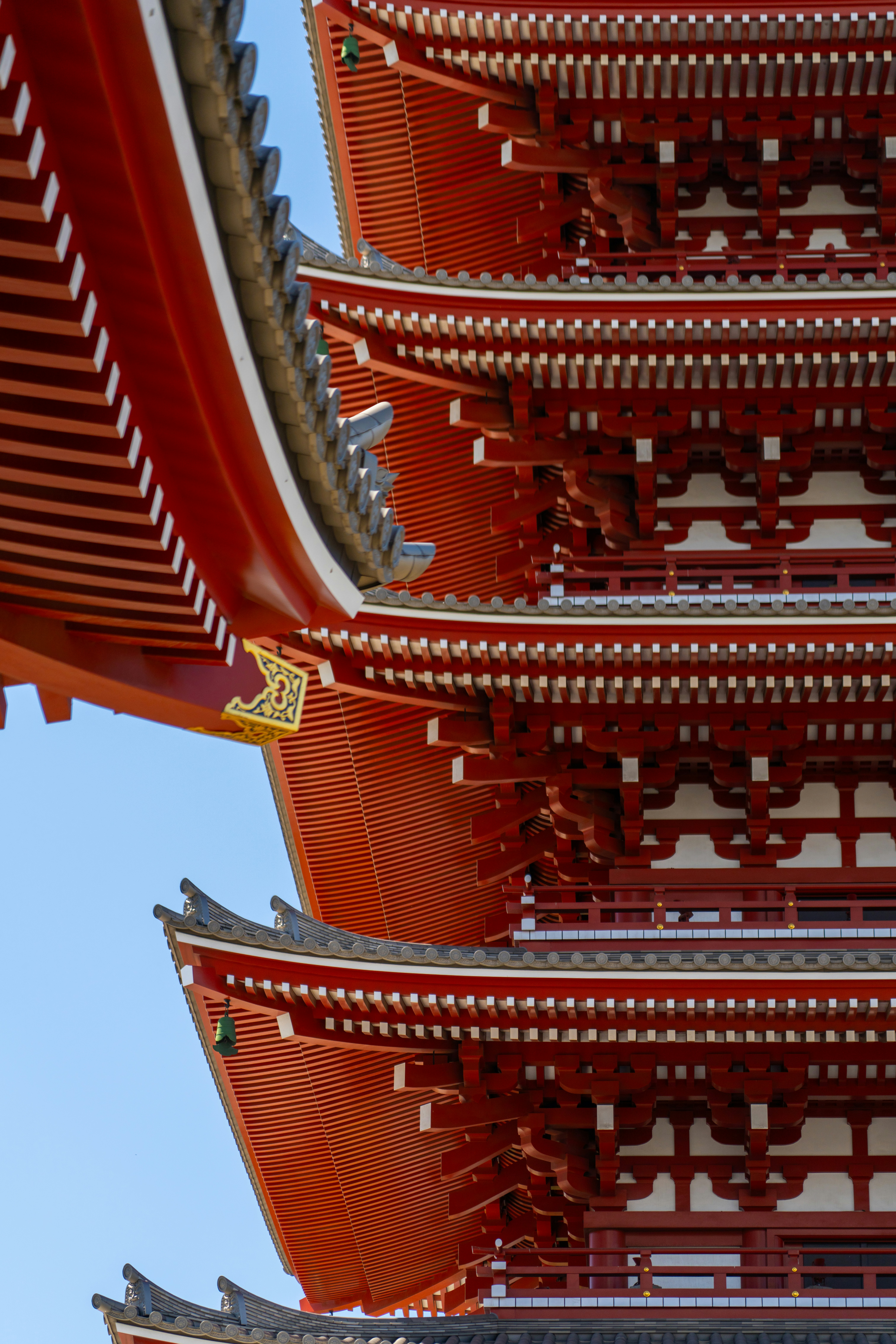 A tall red building with a flag on top of it photo – Free Tokyo Image ...