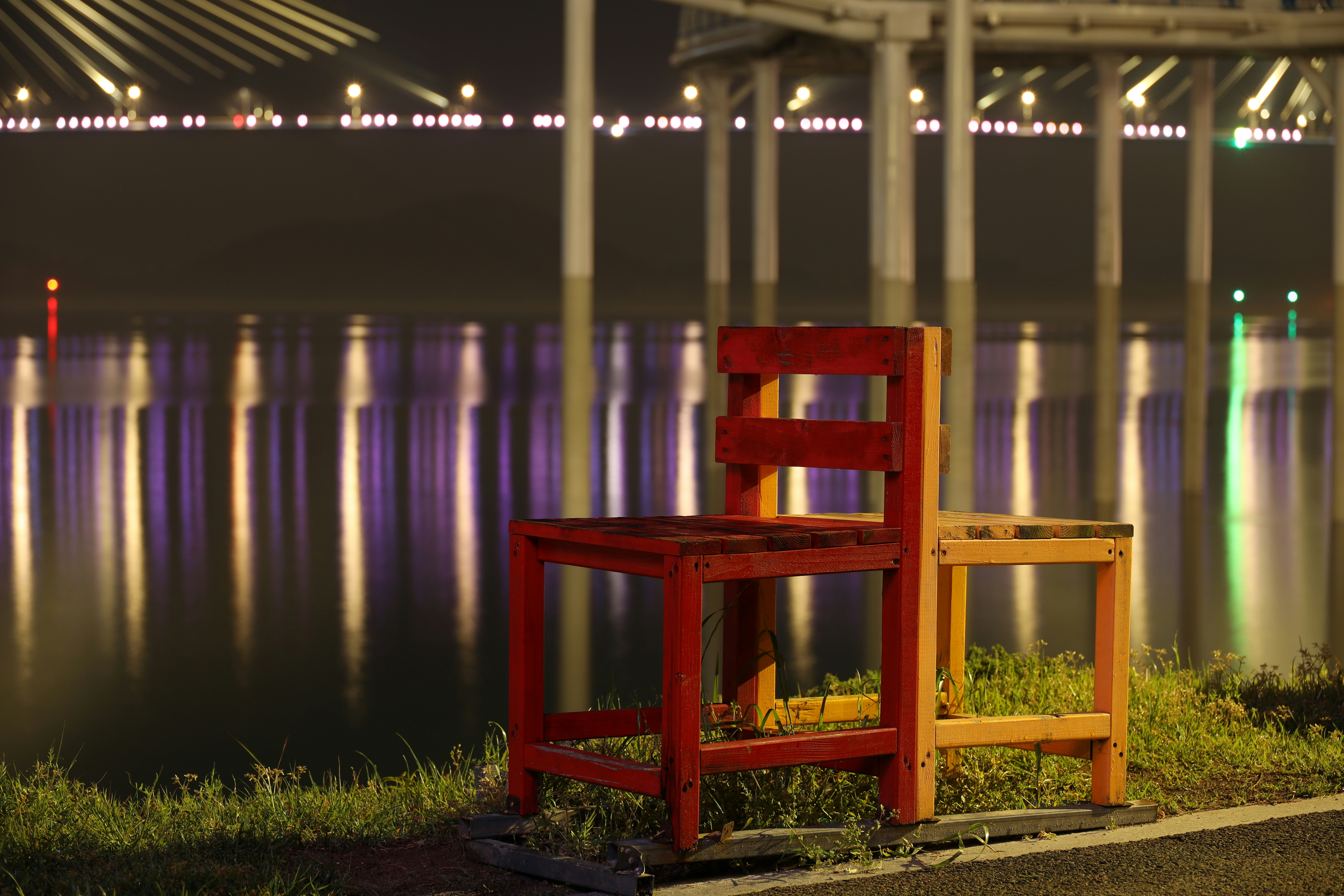 Paused in Color: A Bright Chair by the Riverside Quiet