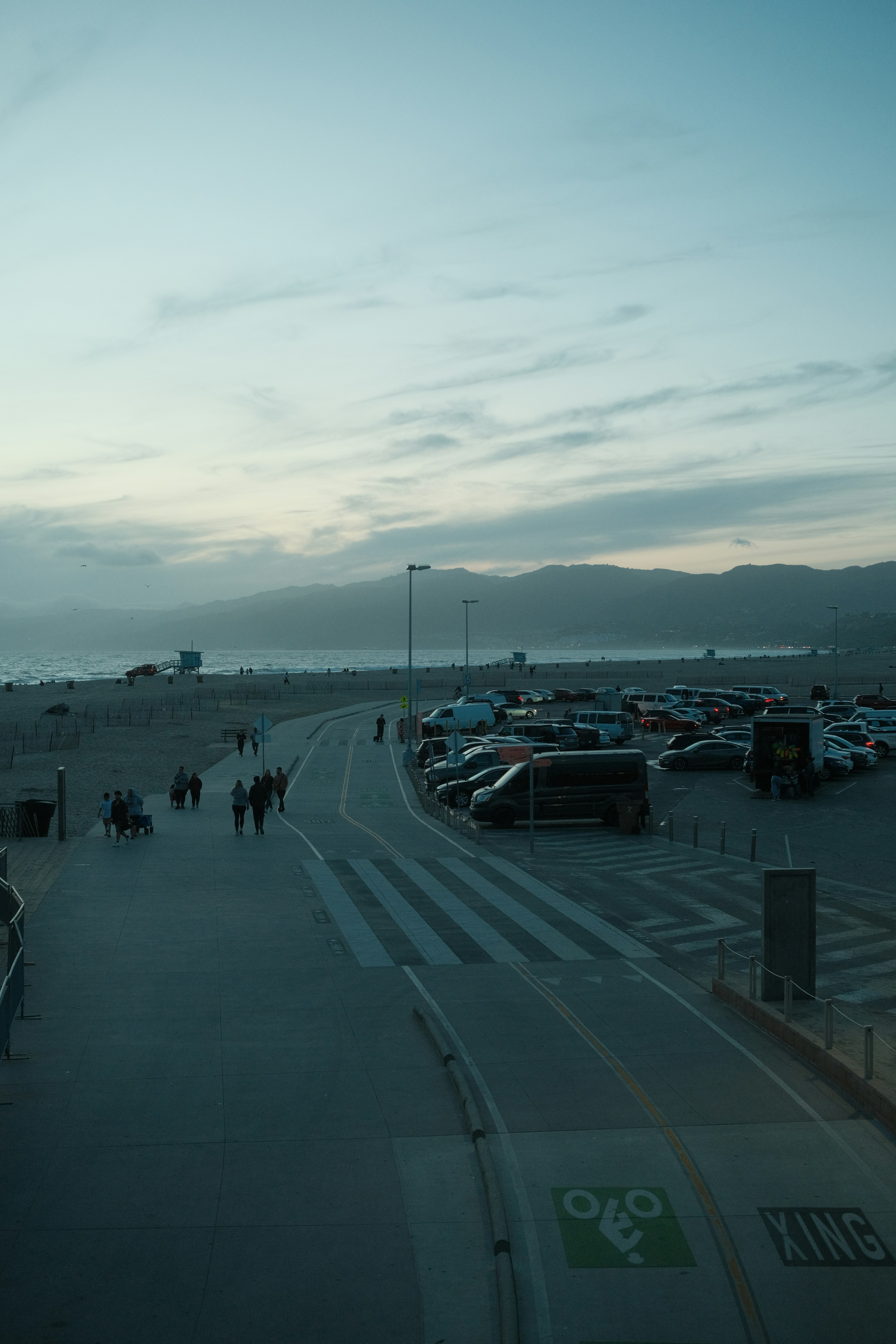 Sunset Promenade by the Pacific: Coastal Walkway and Parking Fading into Dusk