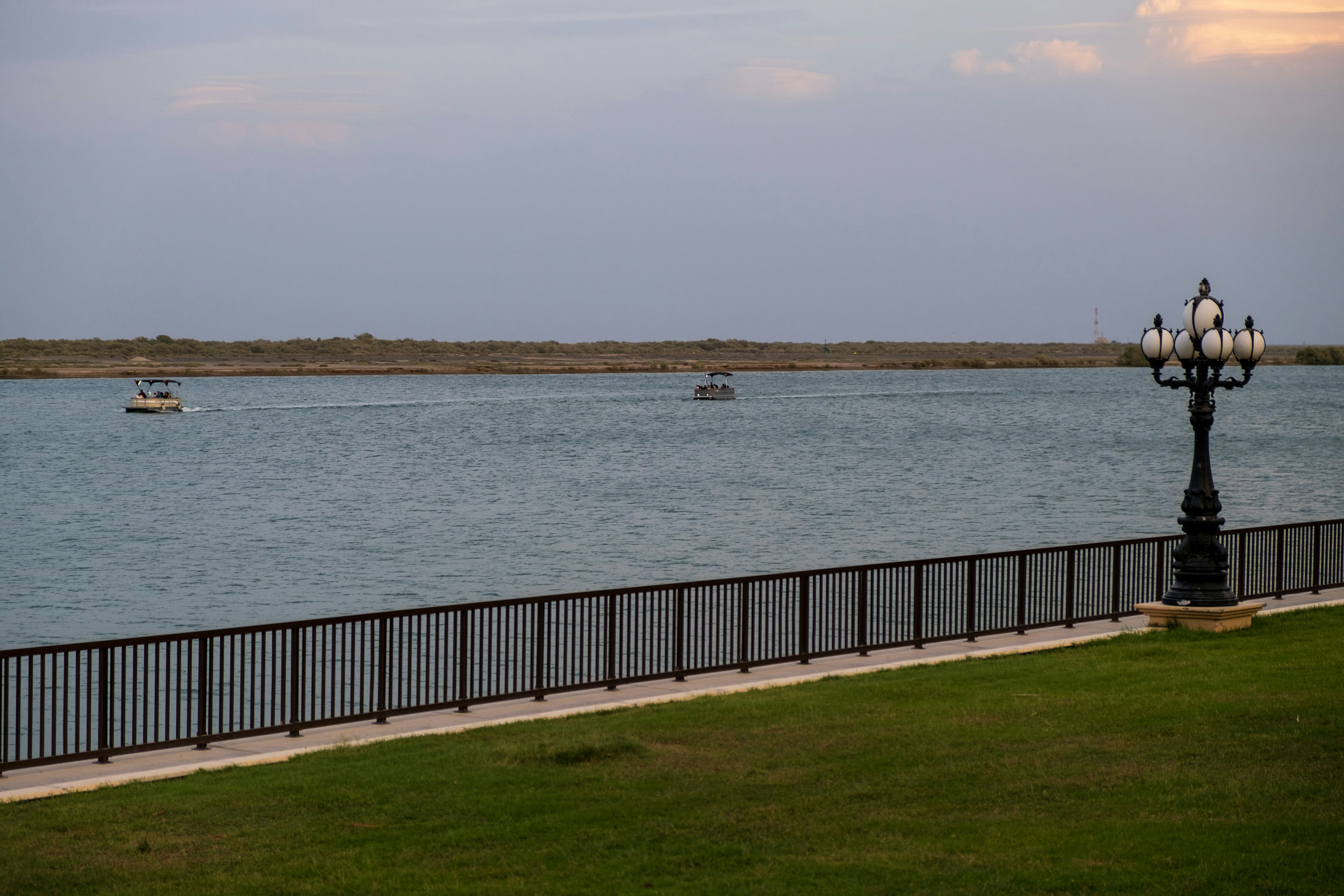 Evening Lantern by the Promenade: Quiet Boats and a Calm Bay