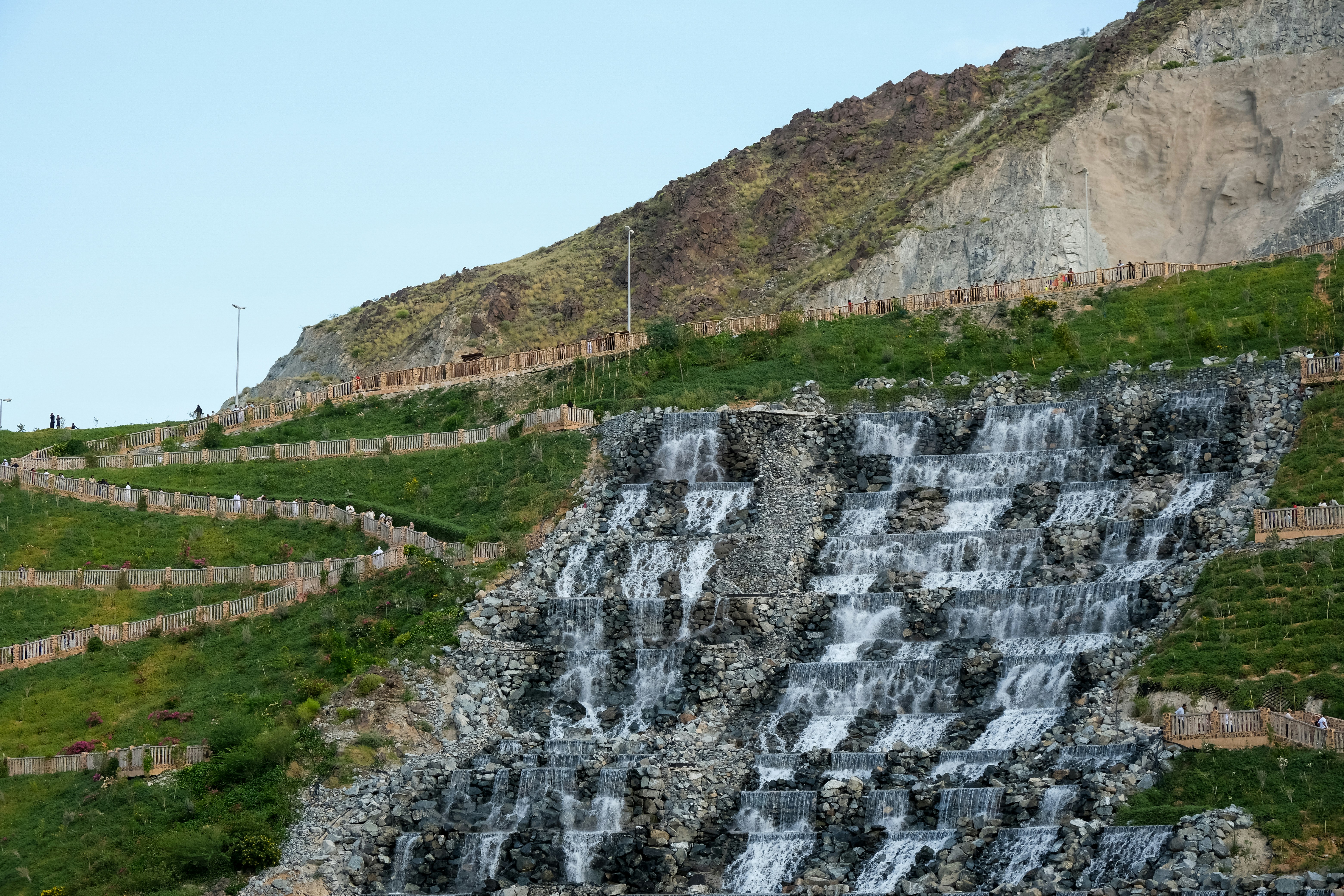 Terraced Cascade: A Stone Staircase Woven Through Green Hills and Flowing Water