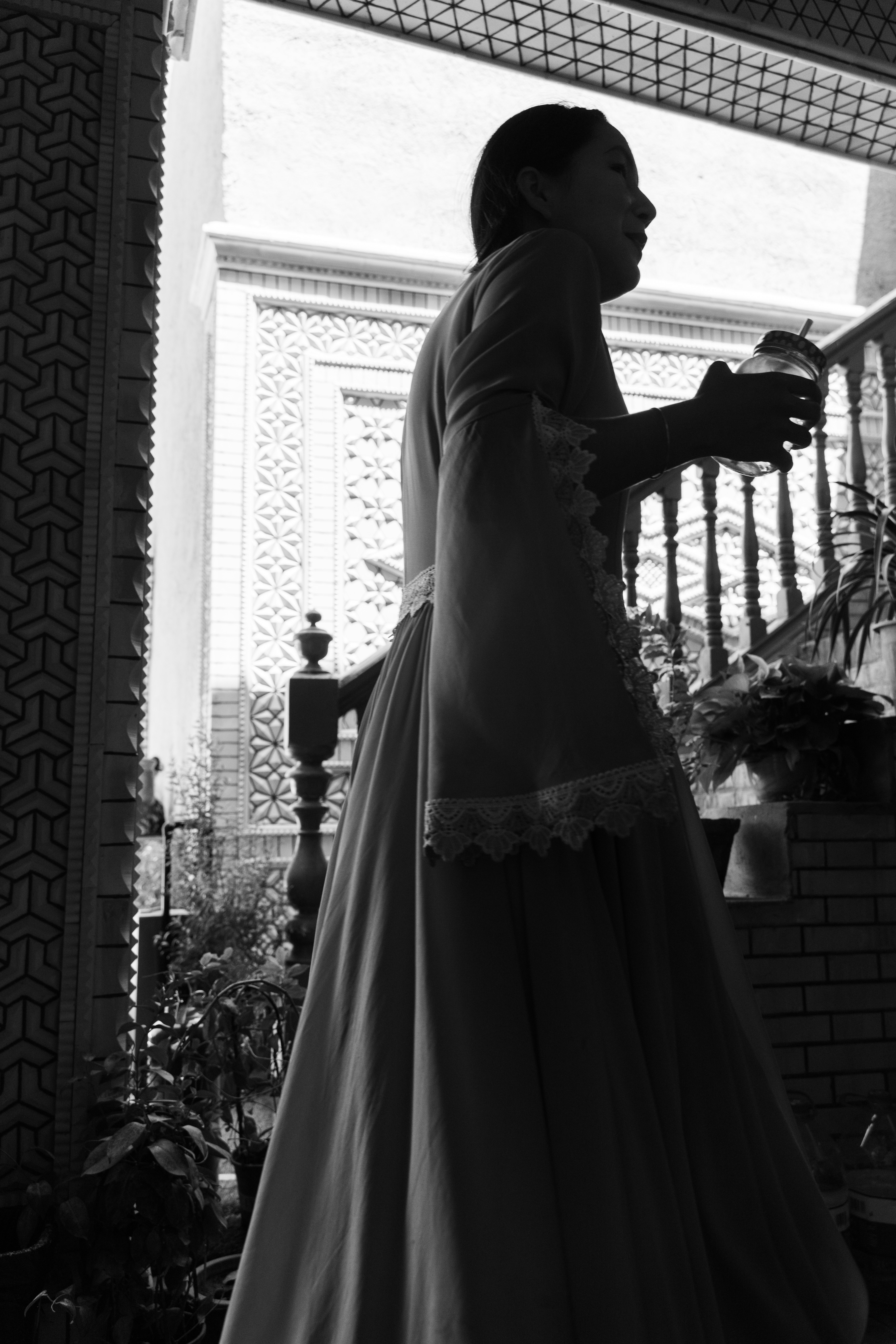 Lace Silhouette on a Veranda Against Ornate Tiles