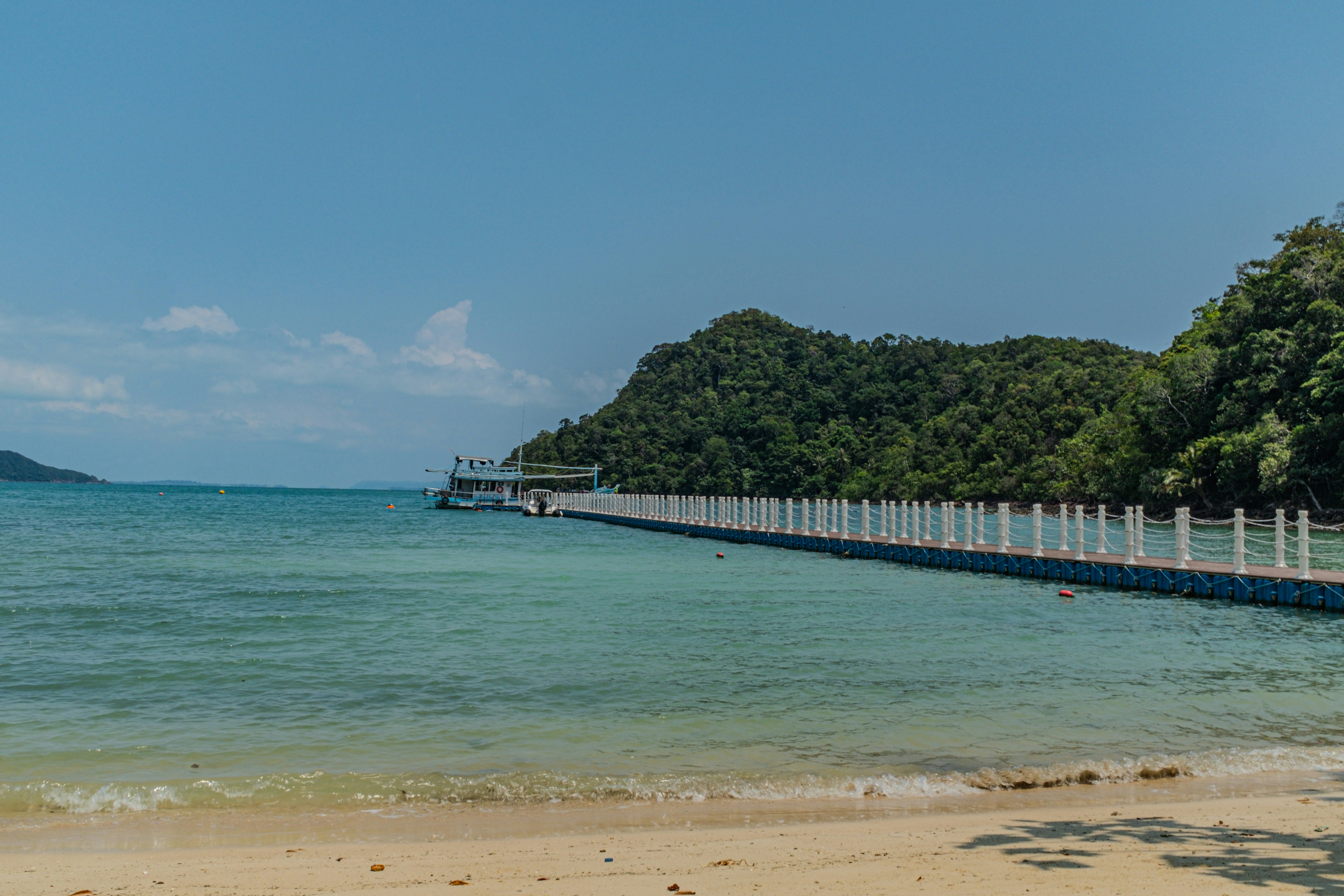 A long pier stretches out into the ocean photo – Free Thailand Image on ...