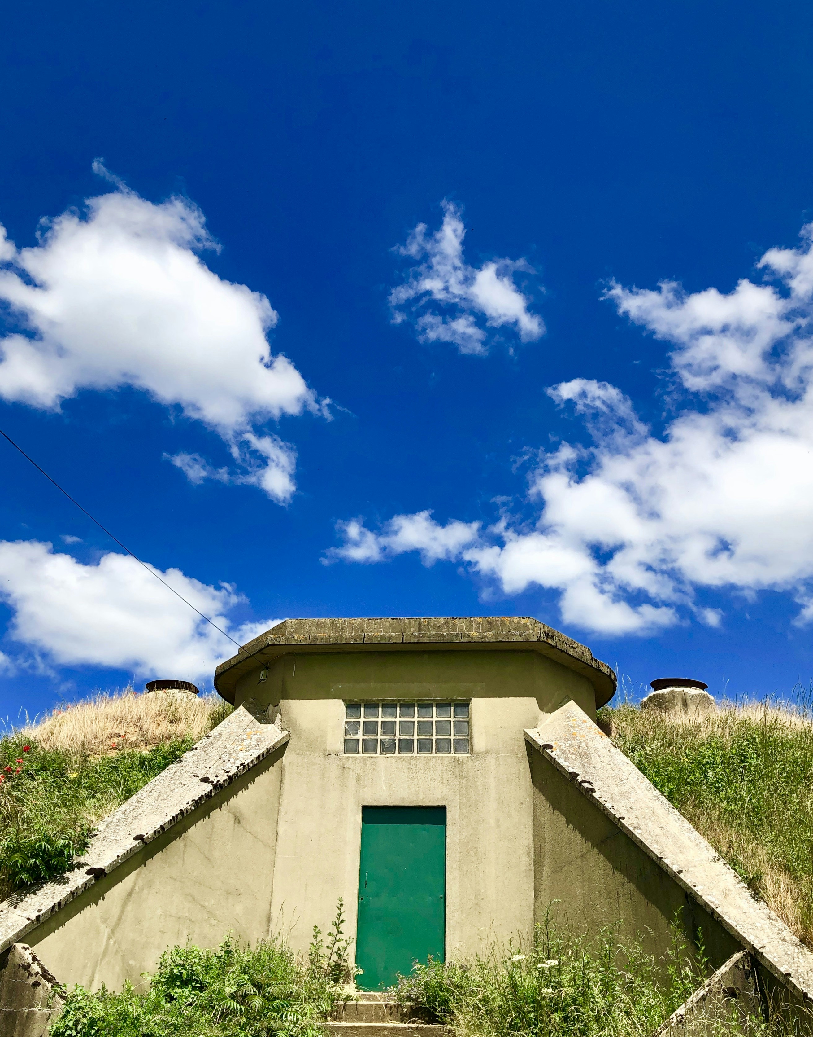 Bunker Under a Bold Sky: Concrete Gateways and Grass Stairway
