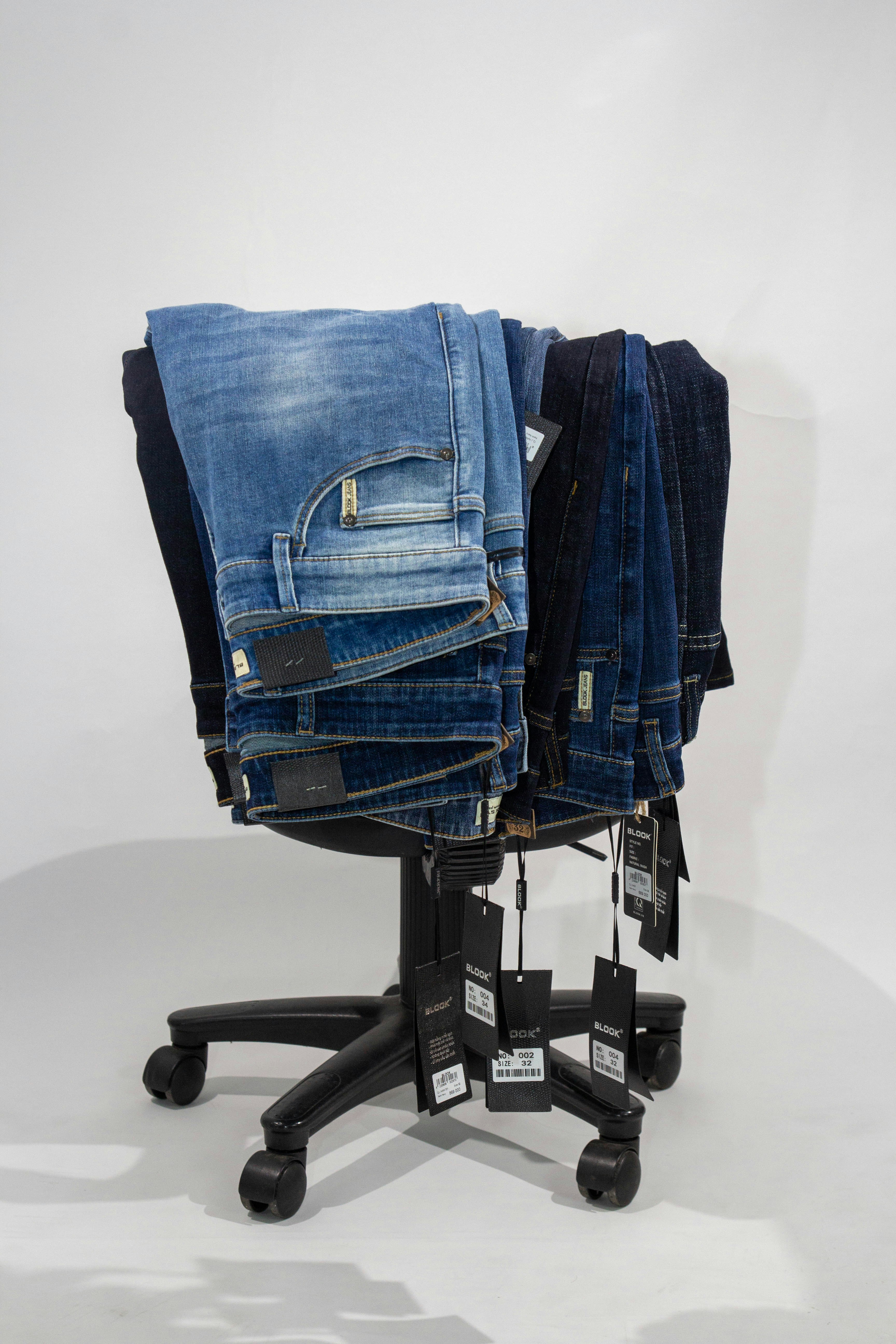 Stacked Denim on a Rolling Mannequin: A Display of Blue Tones
