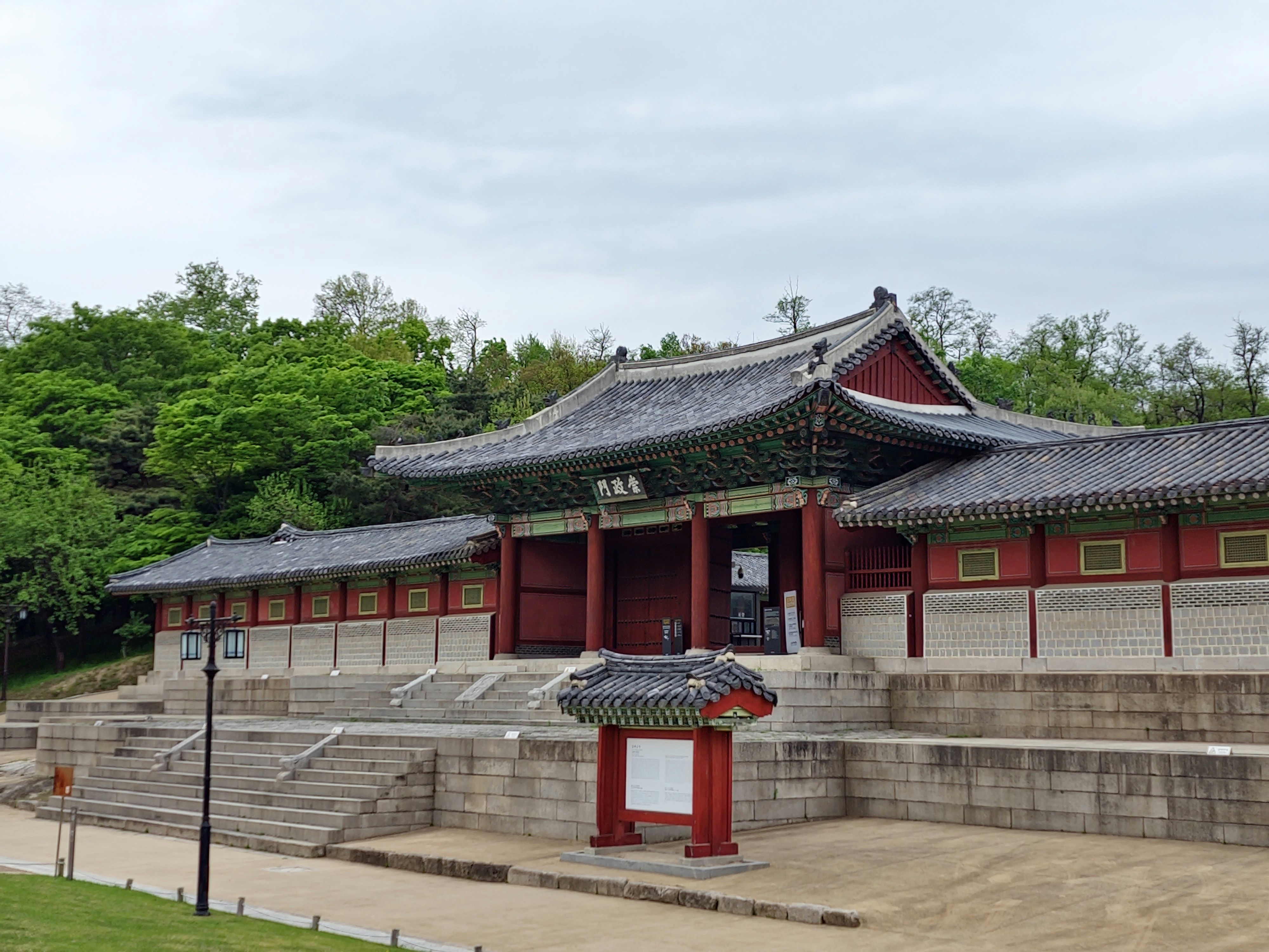 Terraced Temple by the Forest: Red Columns, Sloped Roof, and Tranquil Steps