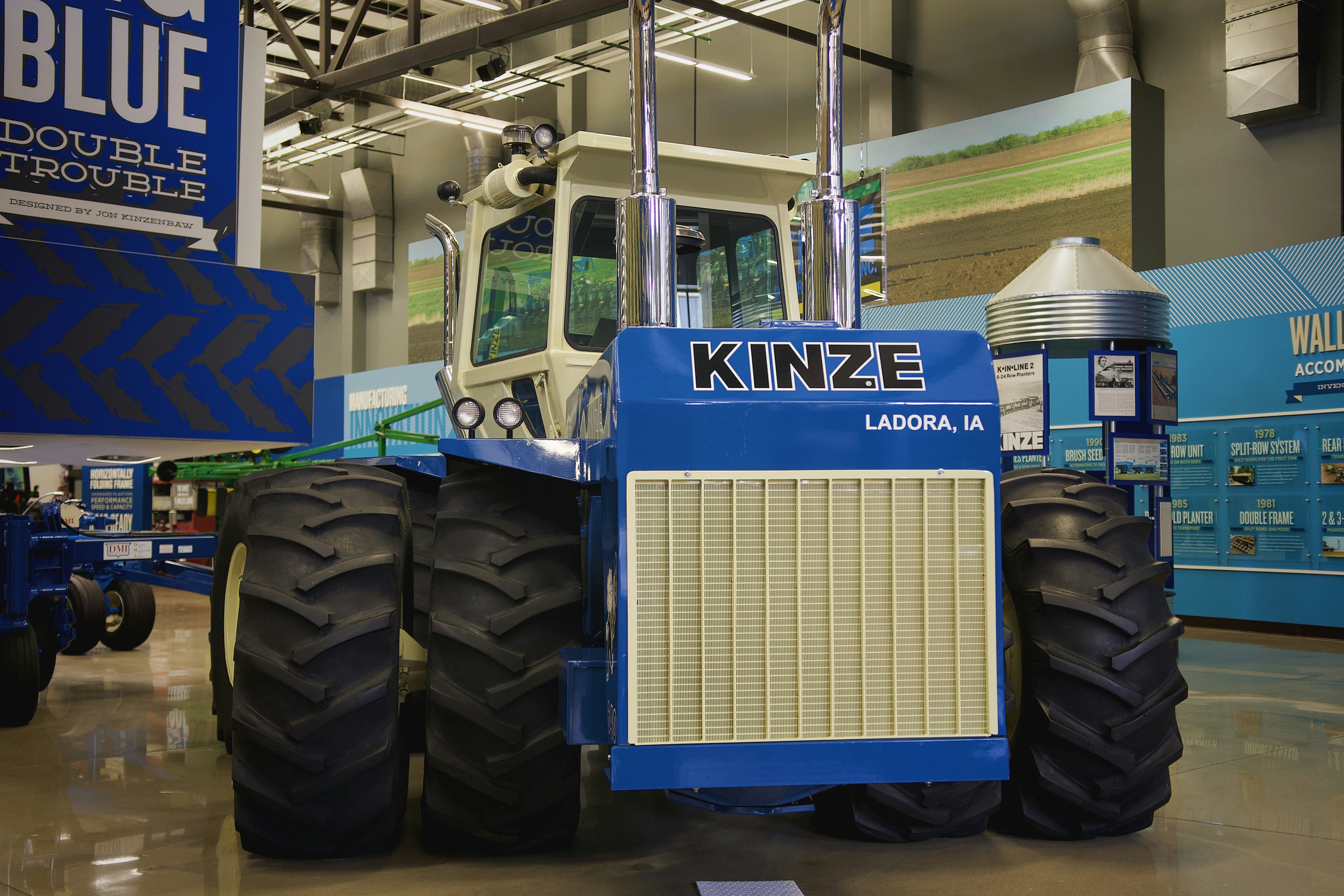 A large blue tractor parked inside of a building photo – Free Museum ...