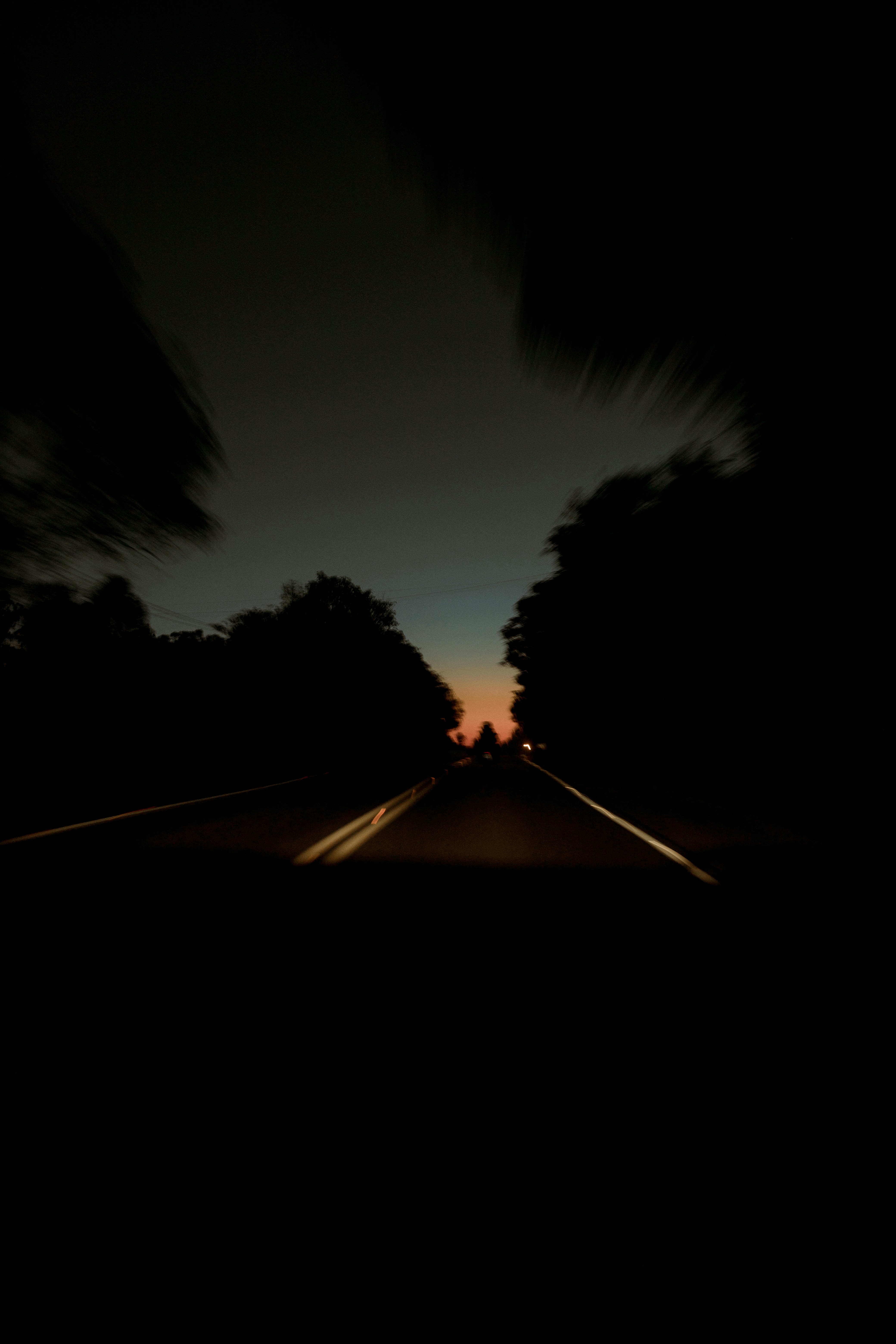 Twilight Vanishing Point: Motion Blur on a Quiet Night Road
