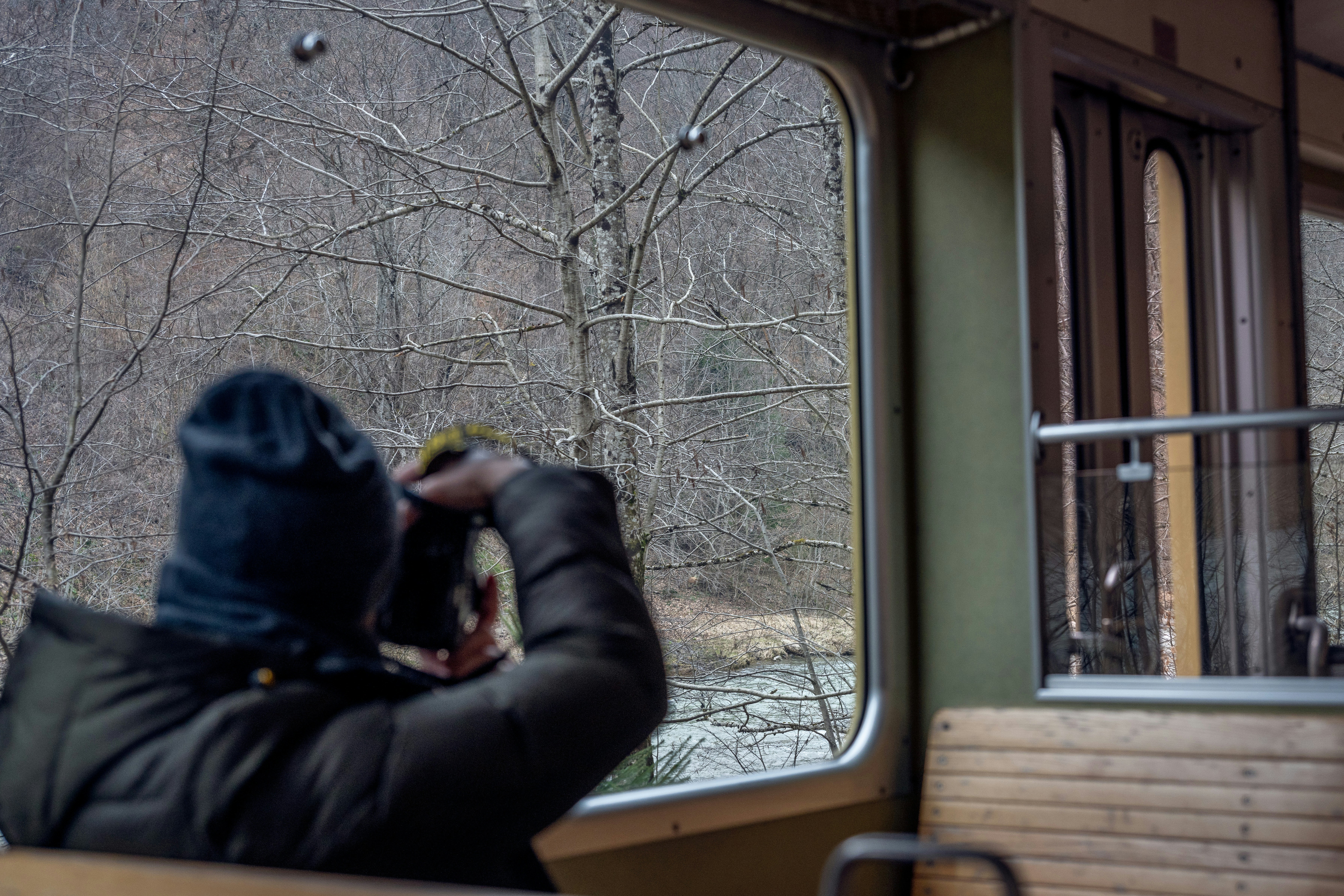 A person taking a picture out a train window photo – Free Free images ...