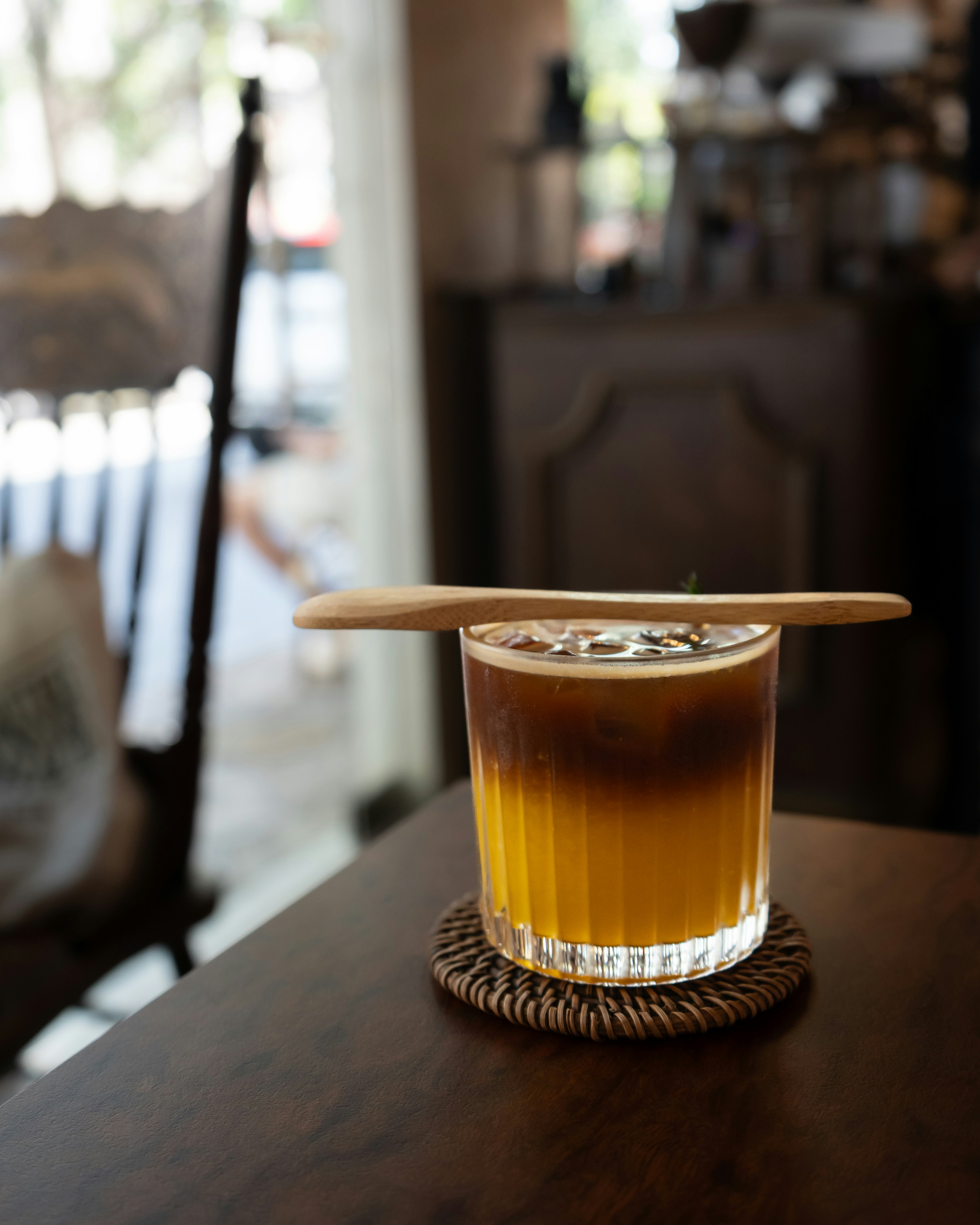 Amber Tumbler with a Wooden Stirrer: Quiet Café Still Life