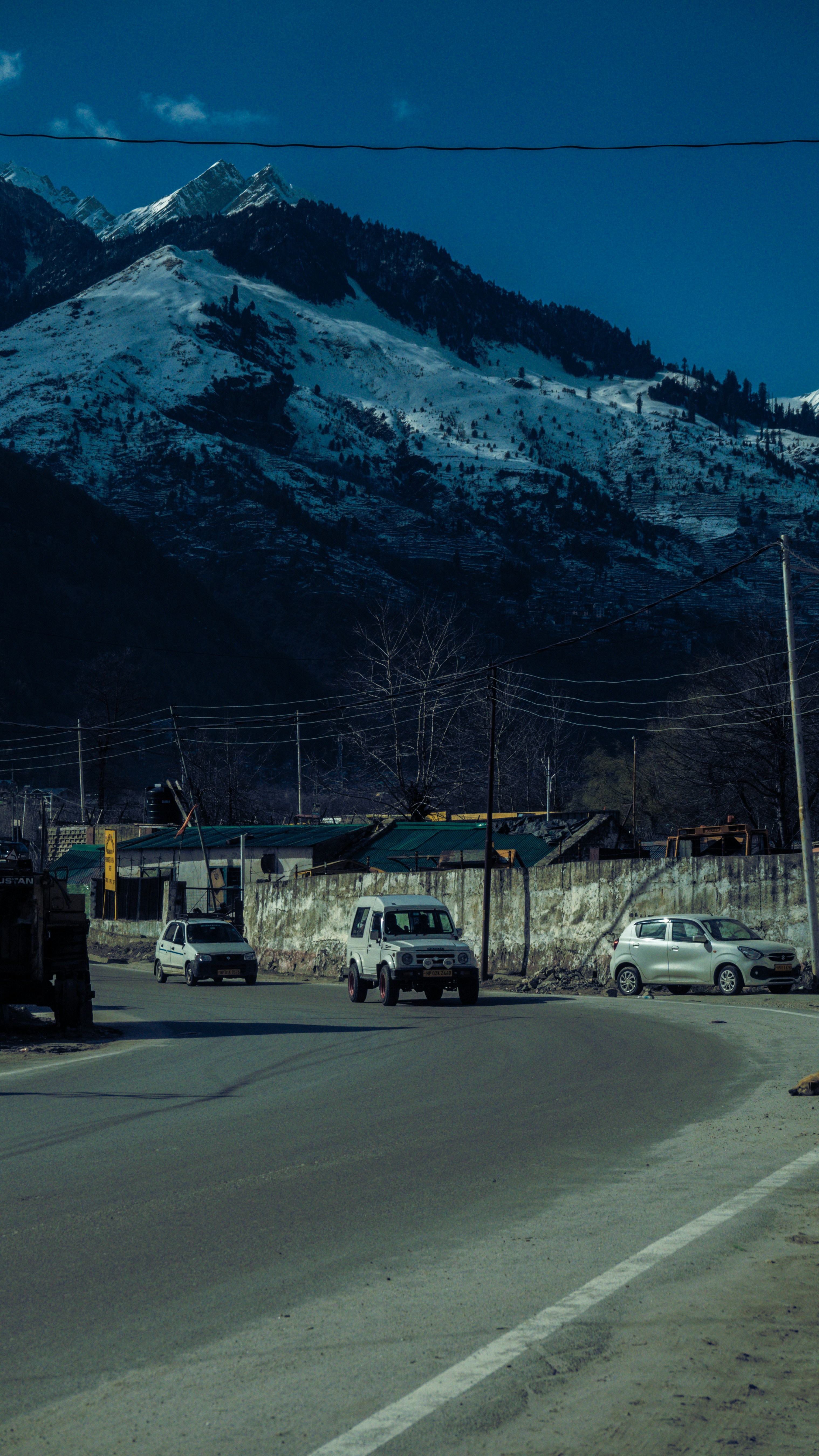 Snow-Capped Silence: A Mountain Town Road Beneath Towering Peaks