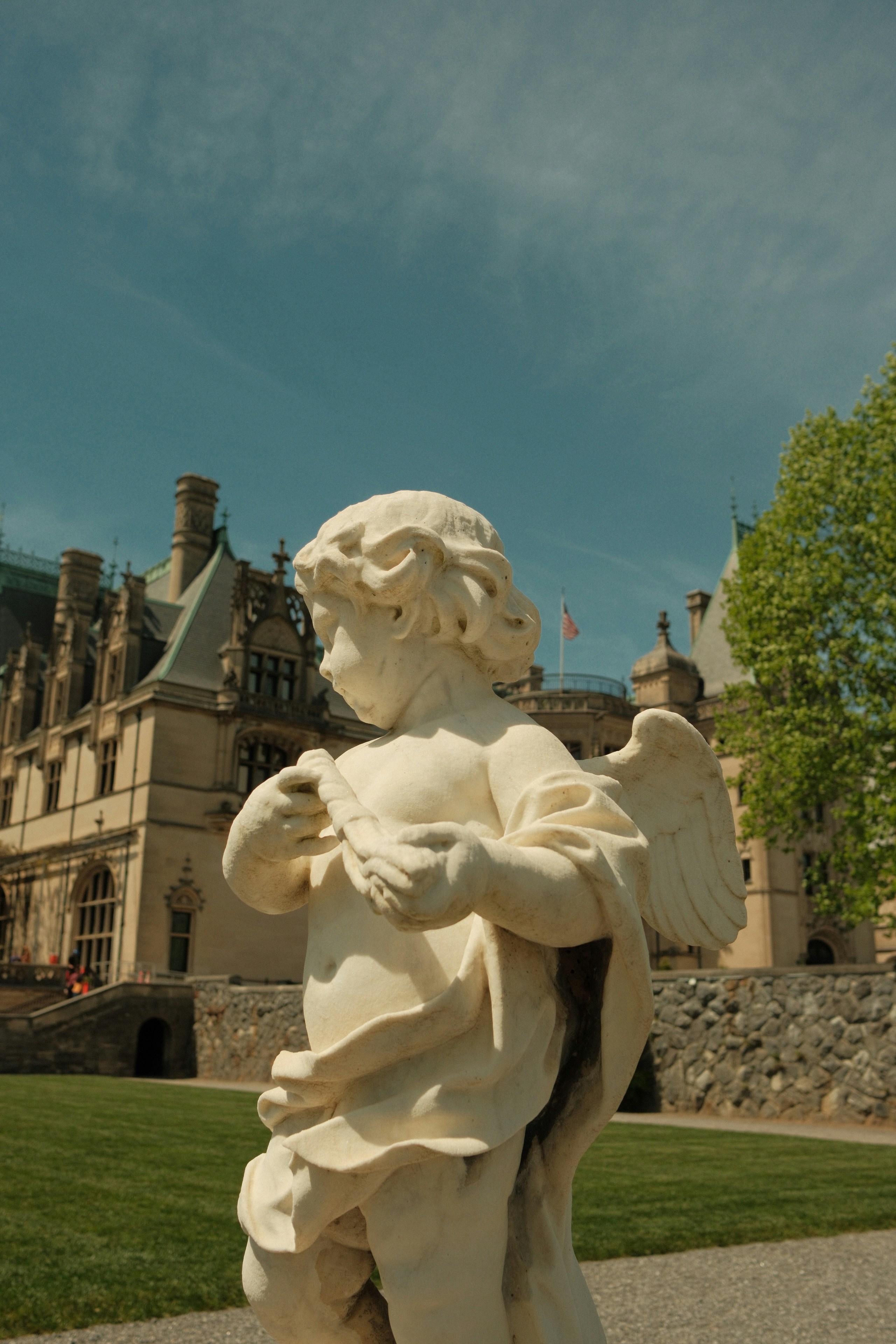 A statue of an angel in front of a castle photo – Free Grass Image on ...