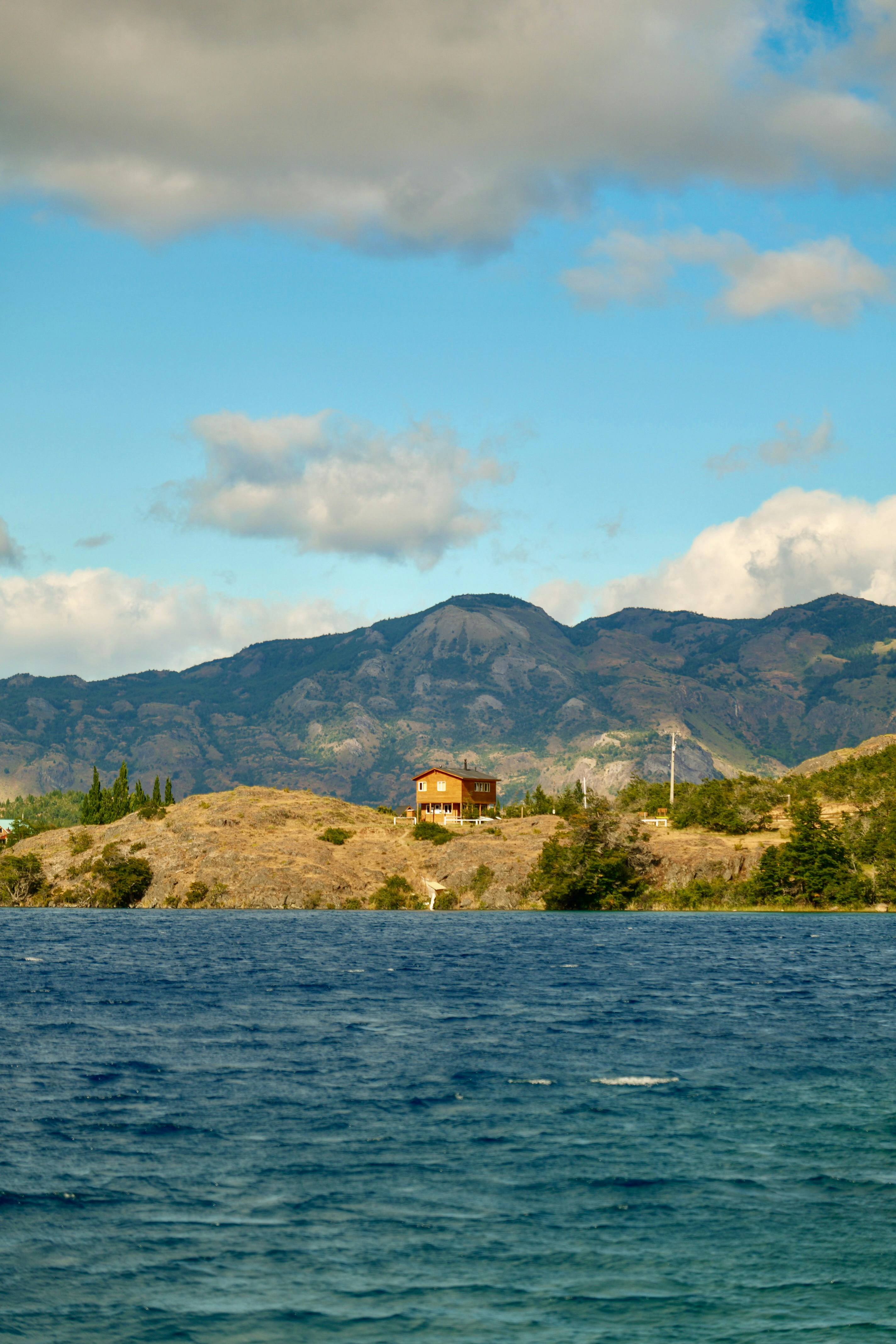 Whispering Shoreline: A Lone Cabin Between Sea and Sky