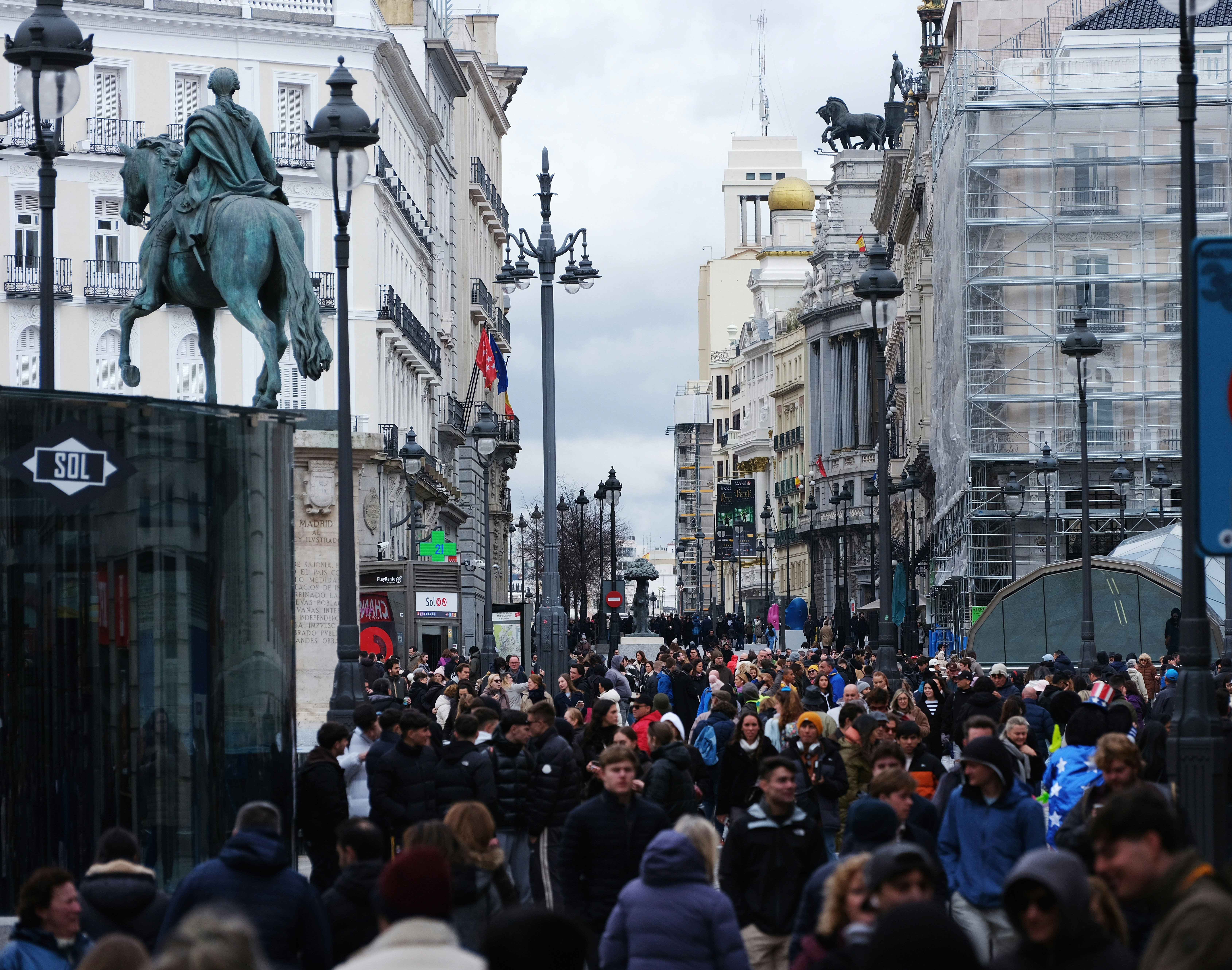 Crowded Champs-Élysées Avenue Beneath Historic Statues