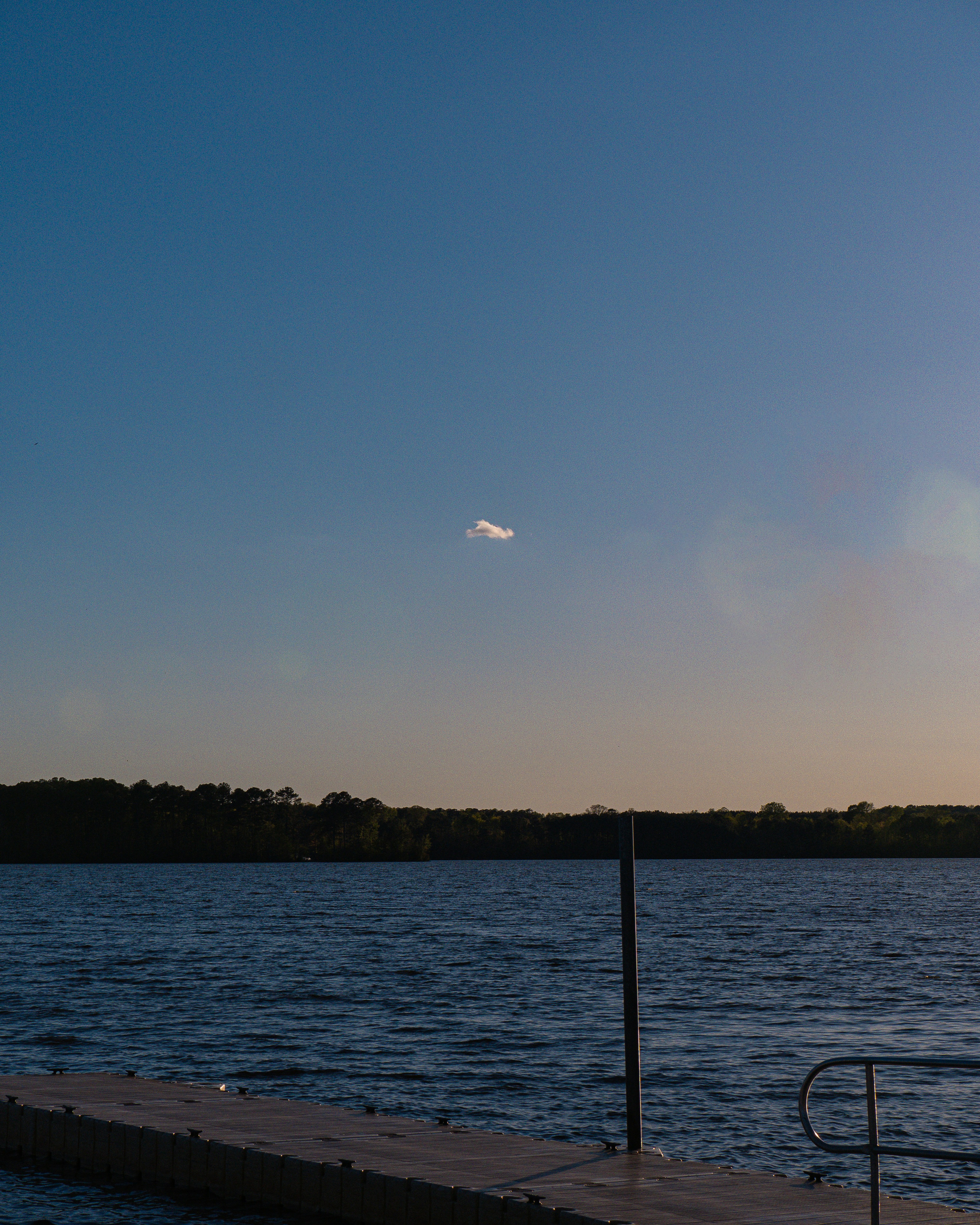 Edge of Dusk: The Lone Dock Post Framing Lake and Sky