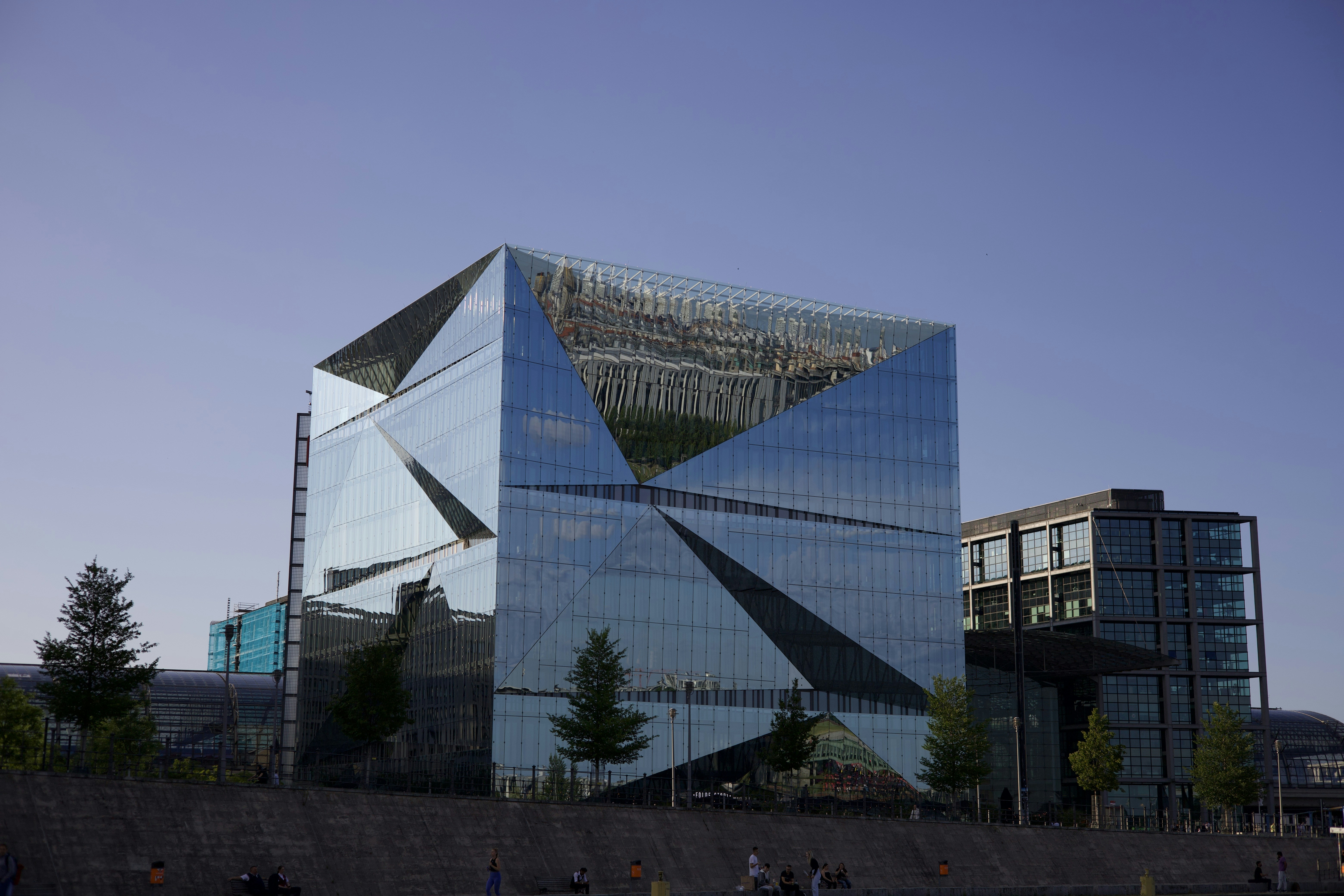 Jigsaw Prism: The Glass Tower Reflecting a Blue Skyline