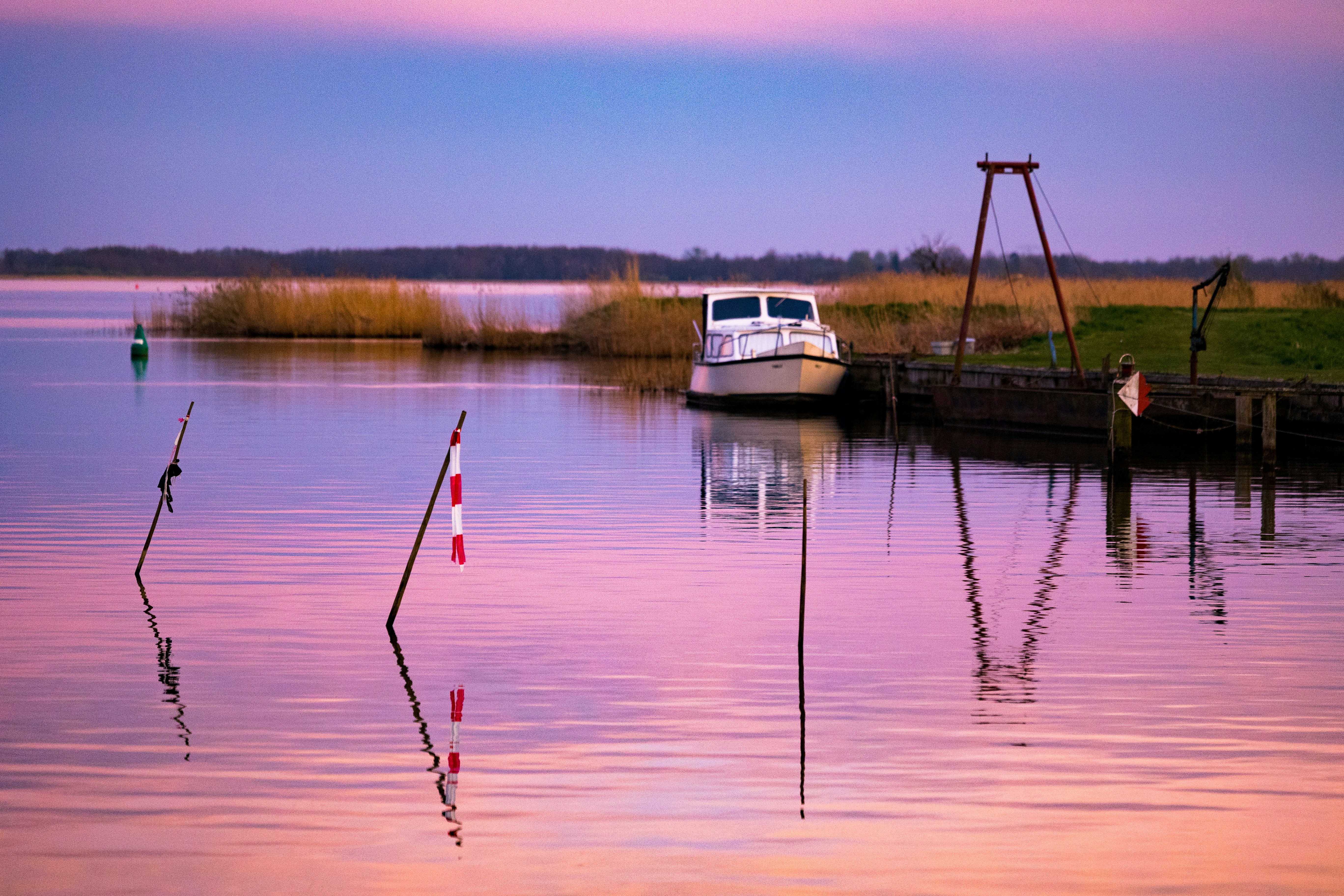 a boat is docked at the end of a pier