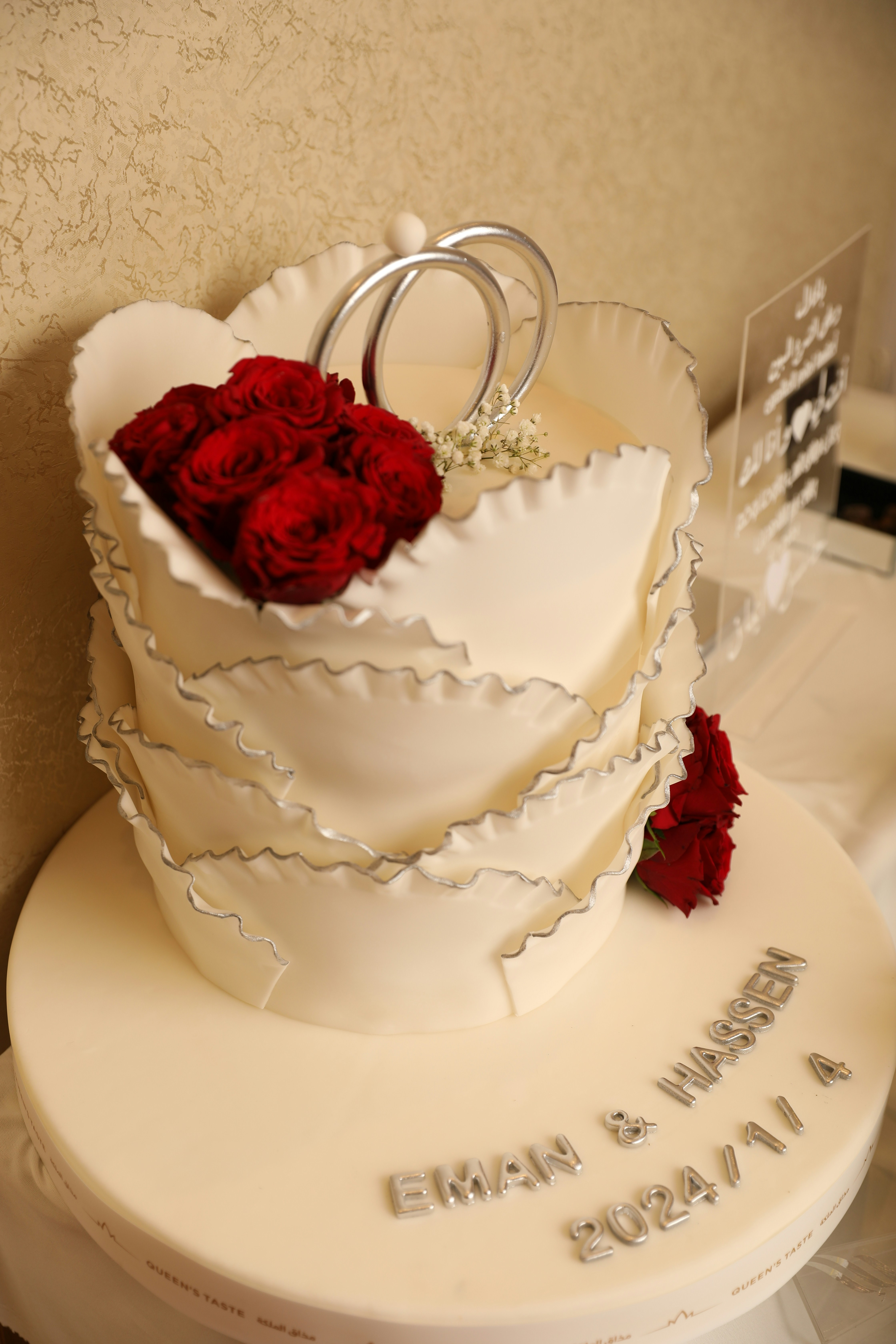 Ruffled Ivory and Ruby: A Wedding Cake with Rings and Roses