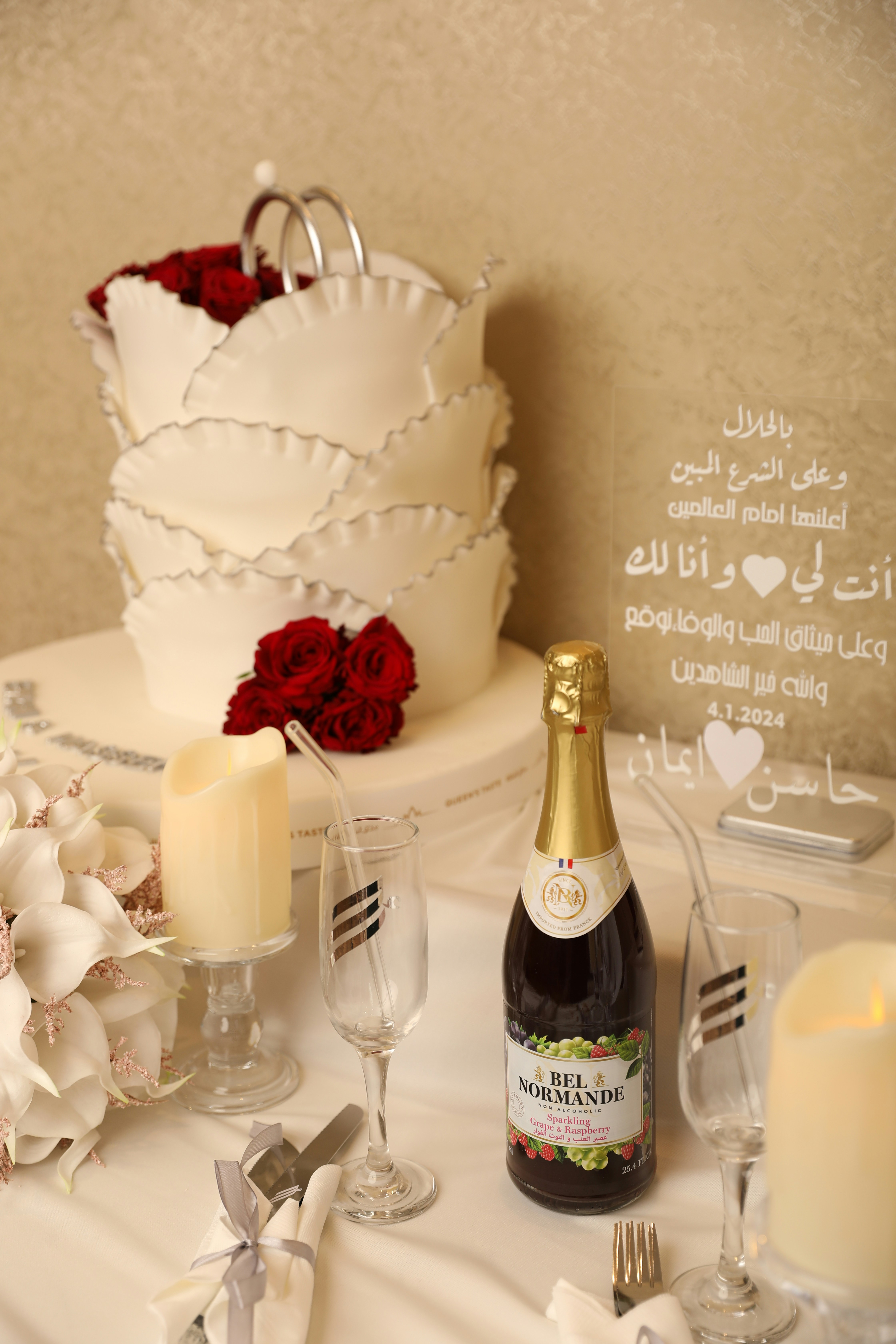 White Tiered Cake and Champagne Centerpiece at a Wedding Table