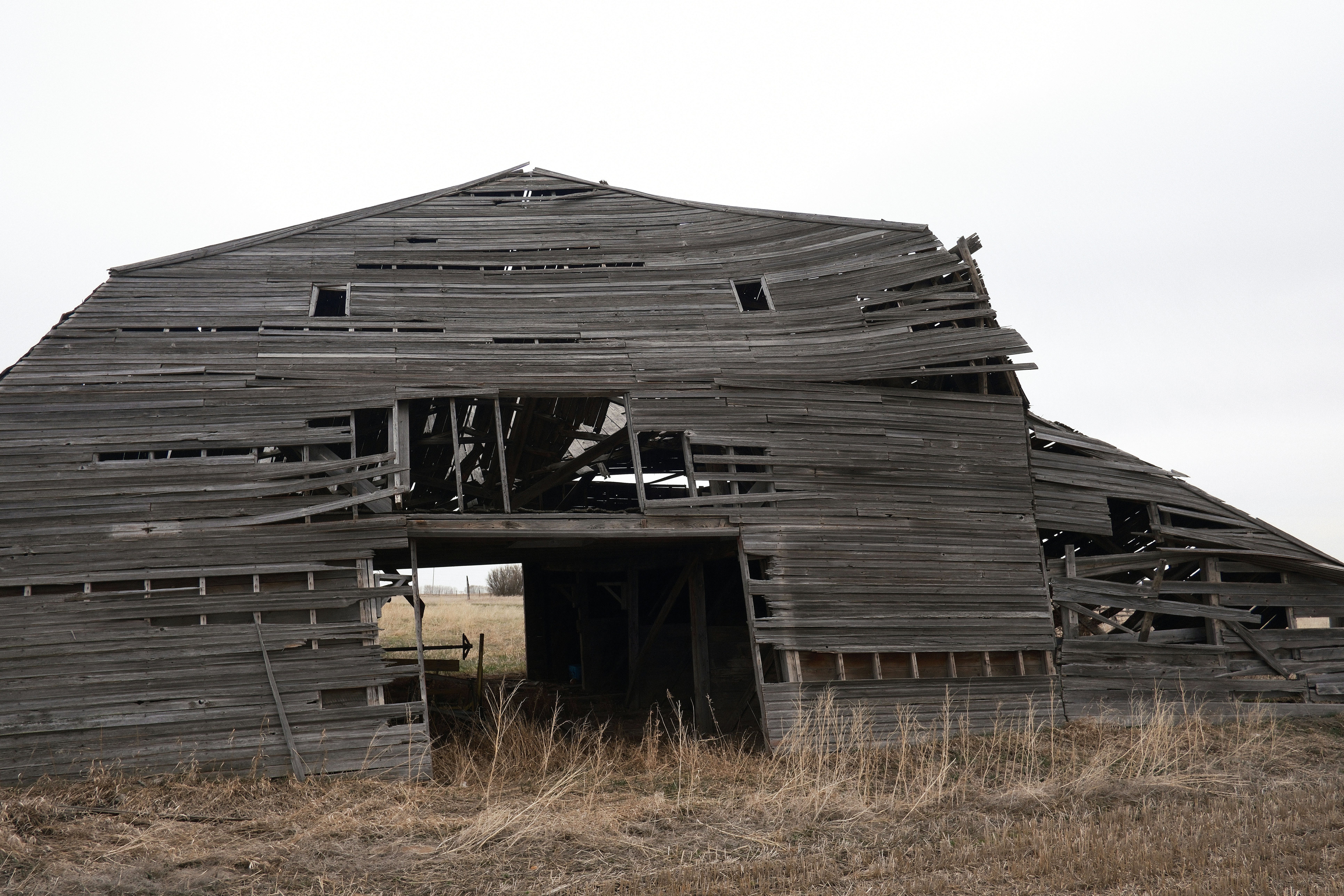 An old barn with a broken down roof photo – Free Black Image on Unsplash
