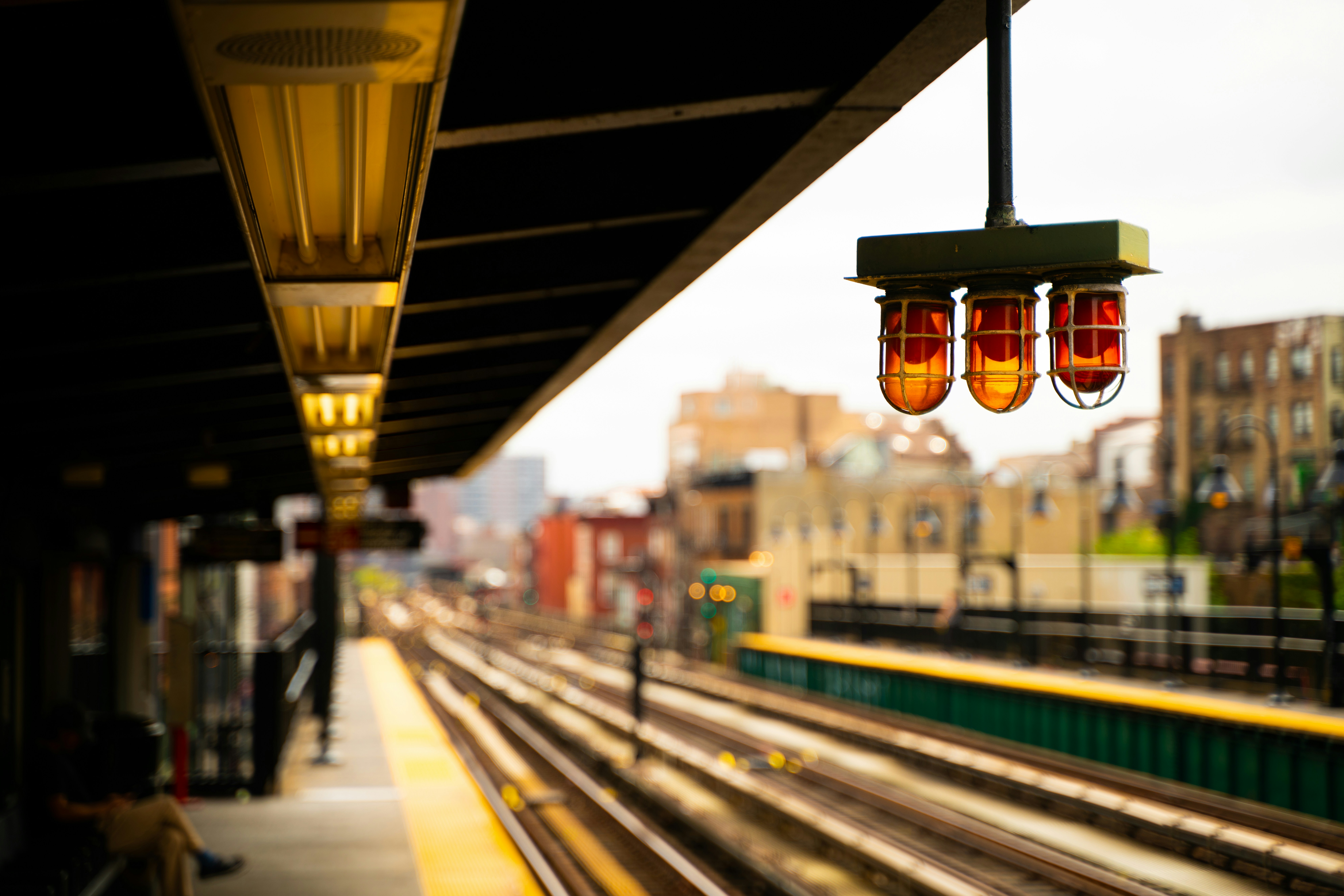 Three Ember Beacons Over a Quiet City Platform