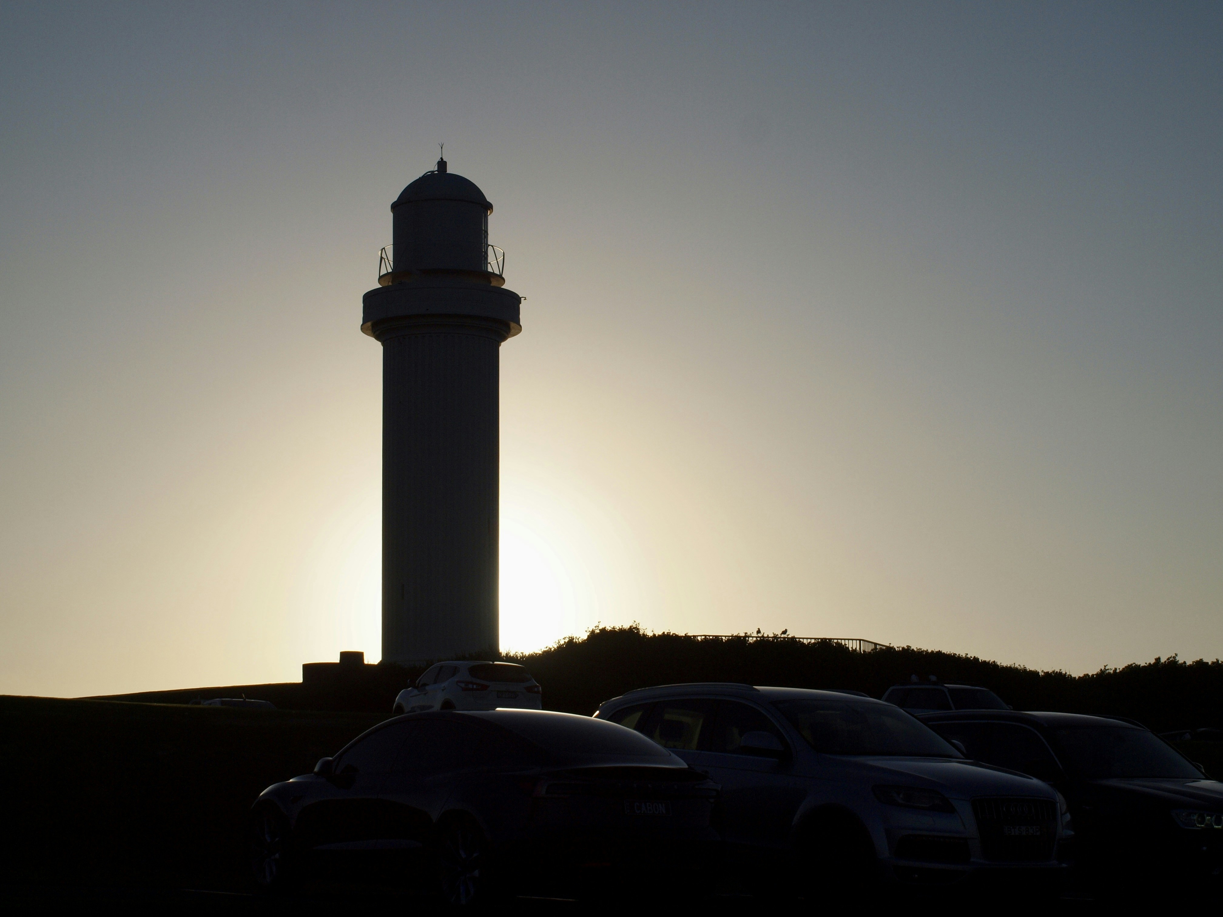 Lighthouse at Dusk: Silhouette Over a Quiet Shoreline