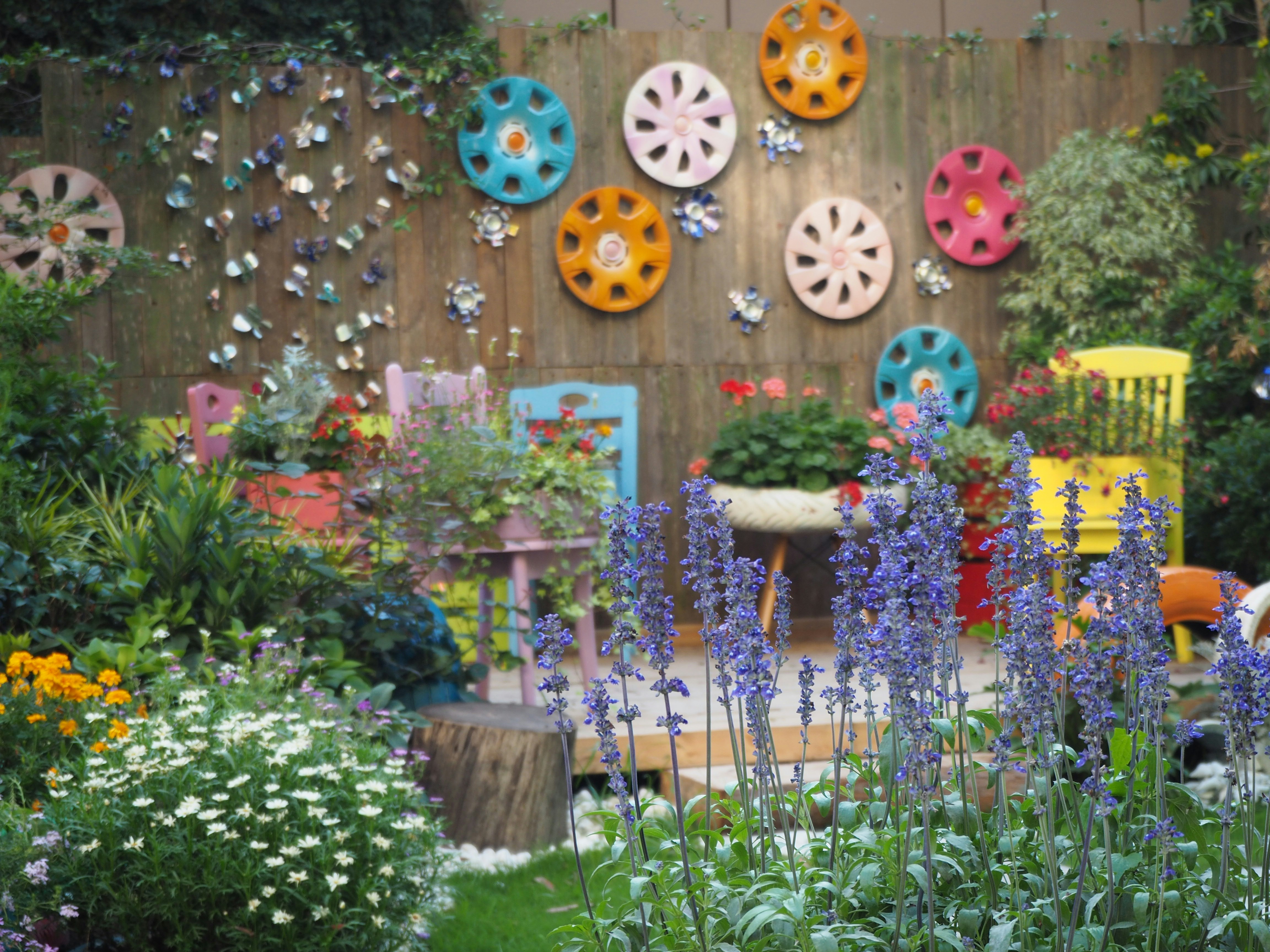 Colorful Garden Mrotif: A Wall of Whimsy Behind Blooming Lavender
