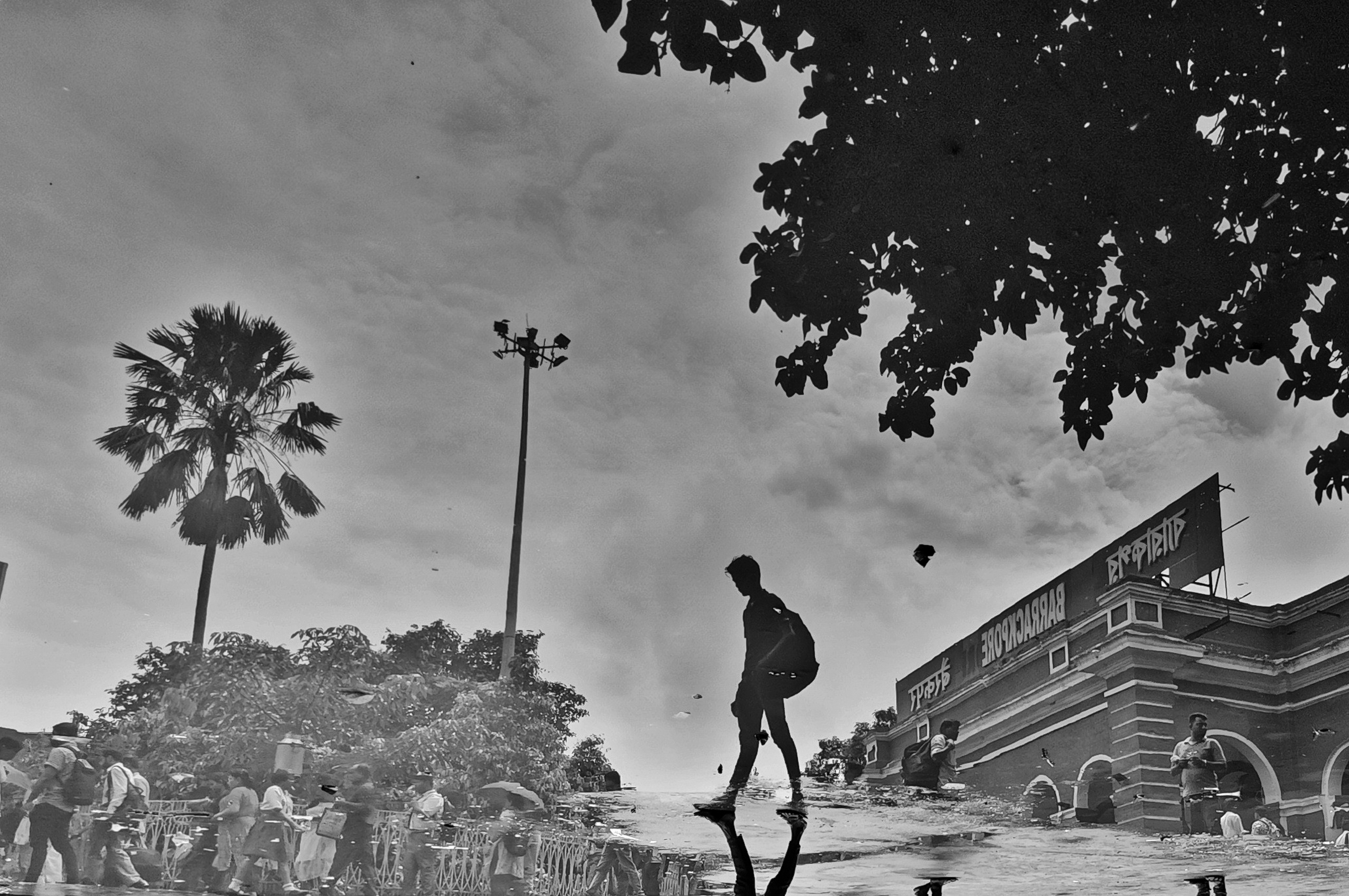 Silhouette at the Edge: A Walkway Between Sky and Street