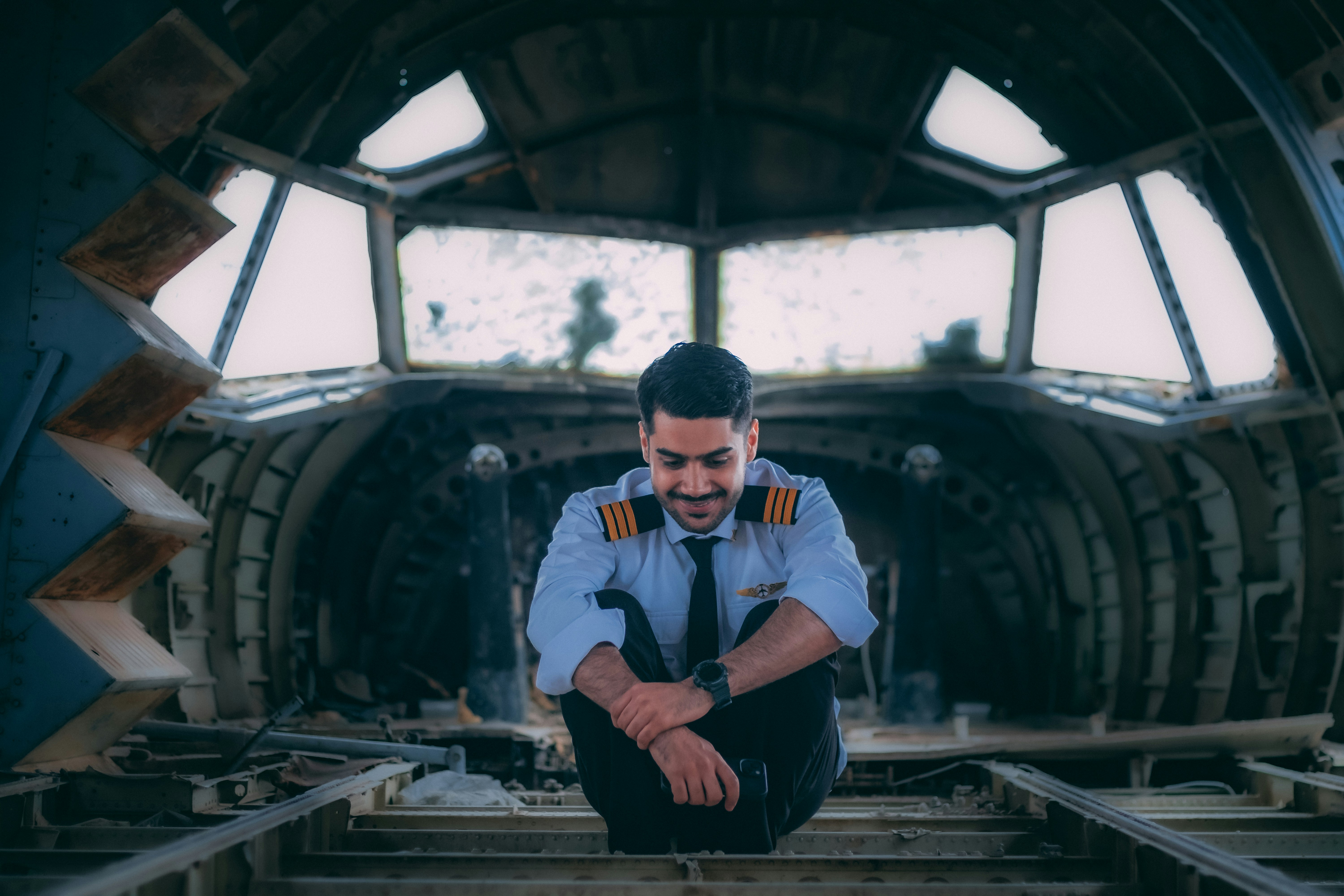 A man in uniform sitting on a set of stairs photo – Free Man Image on ...
