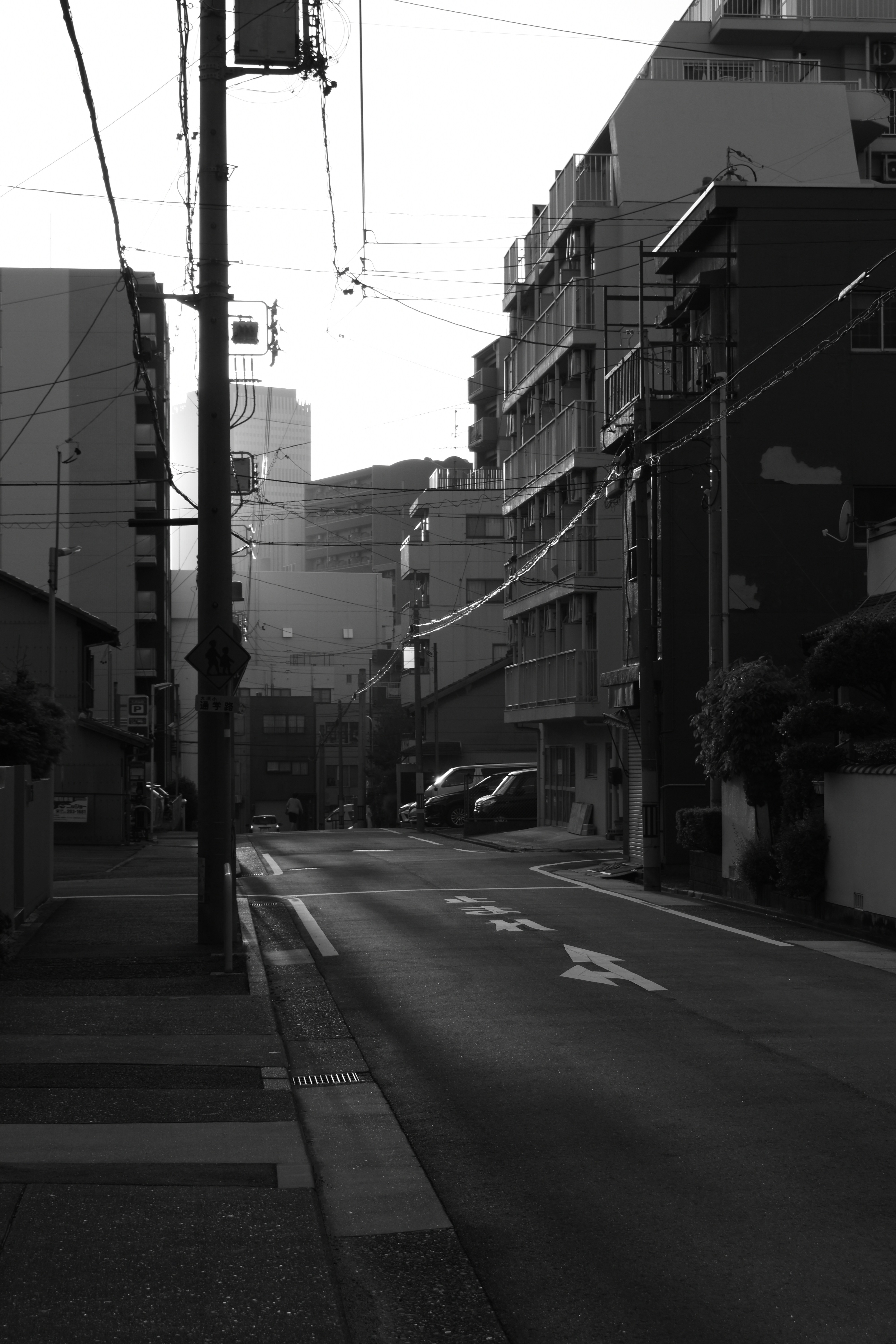 black and white,empty street,japan | a black and white photo of a city street