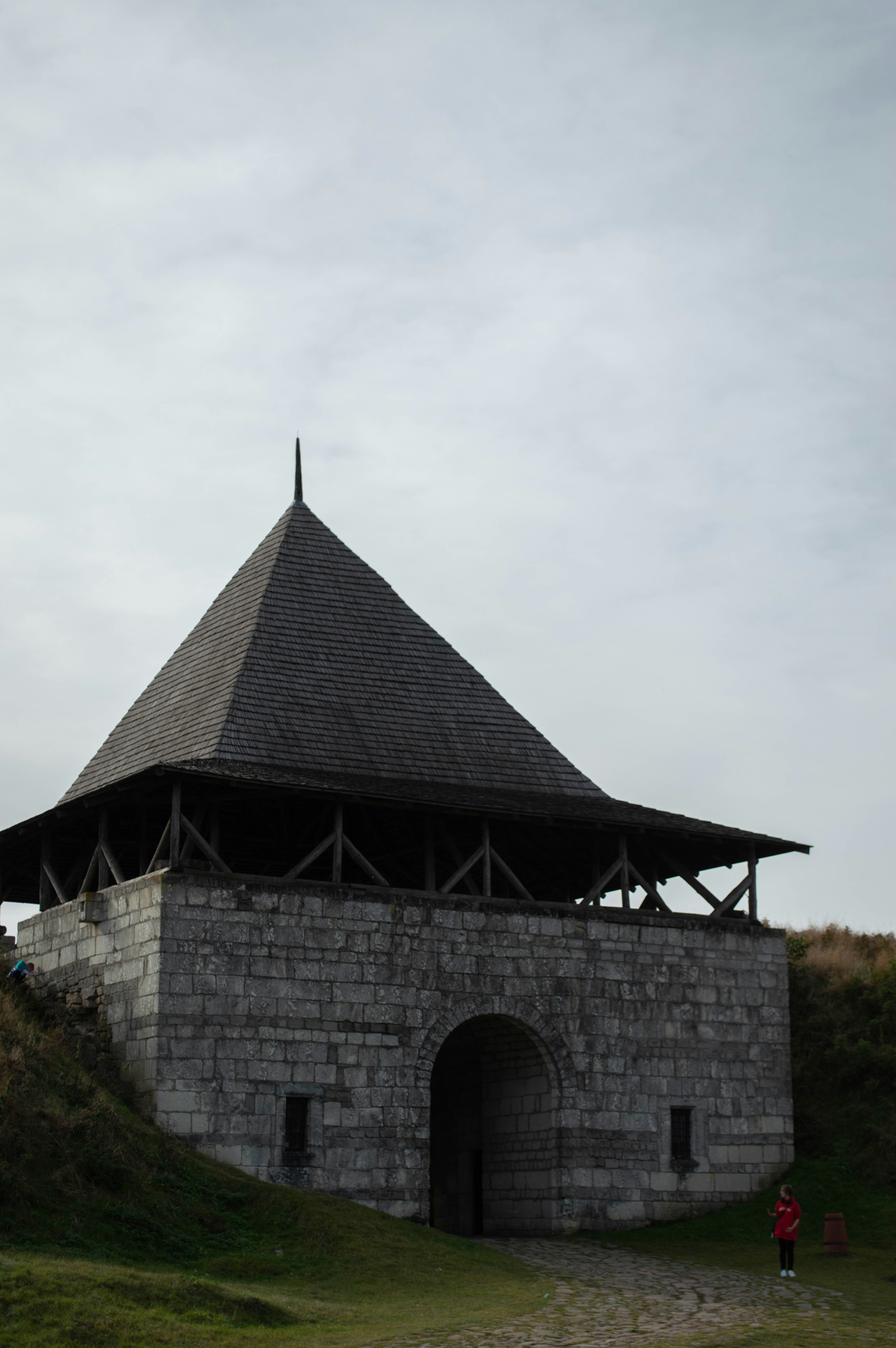 Pyramid-Roofed Gatehouse at a Weathered Stone Bastion
