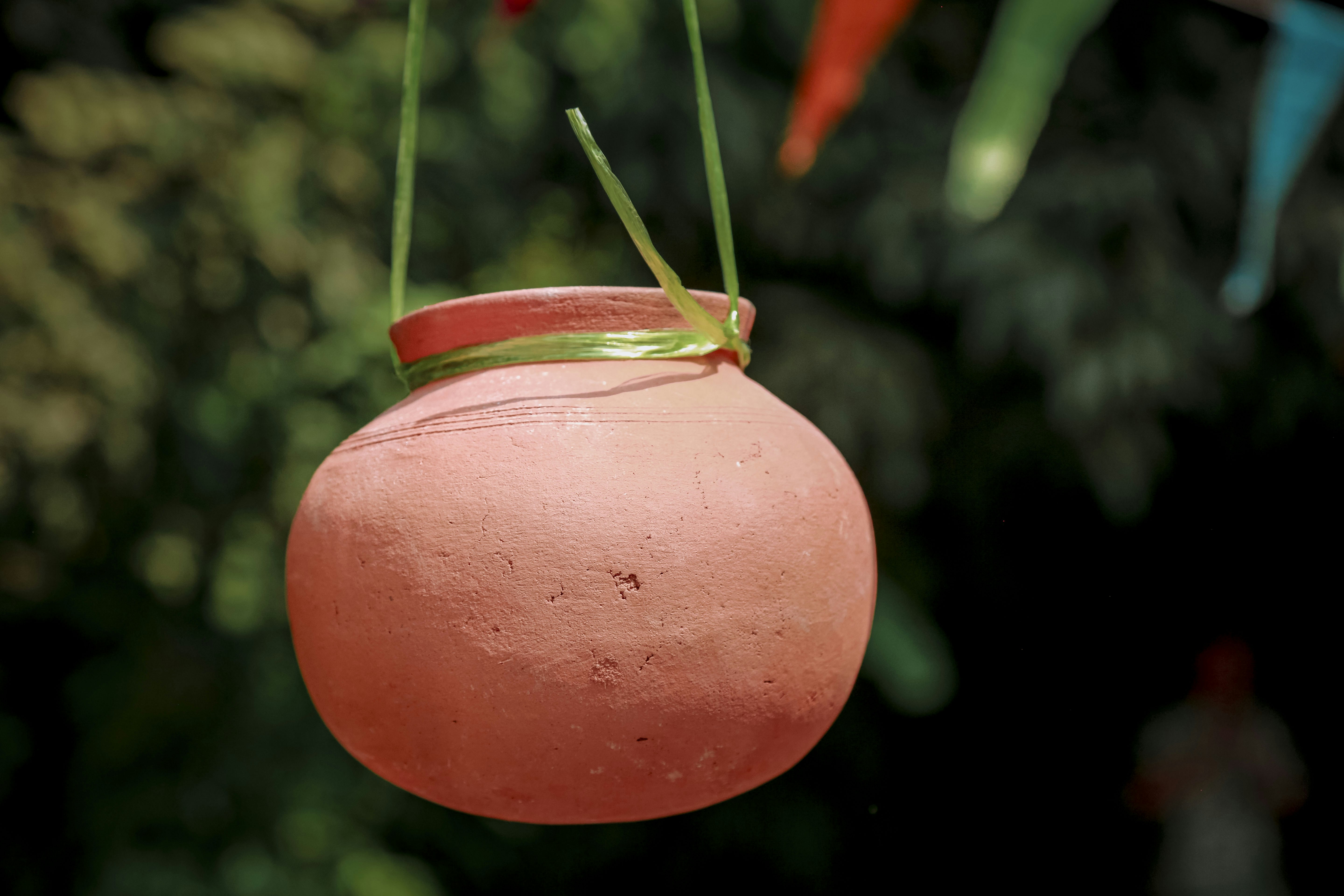 Coral Paper Lantern Suspended Amid Soft Bokeh and Festive Flags