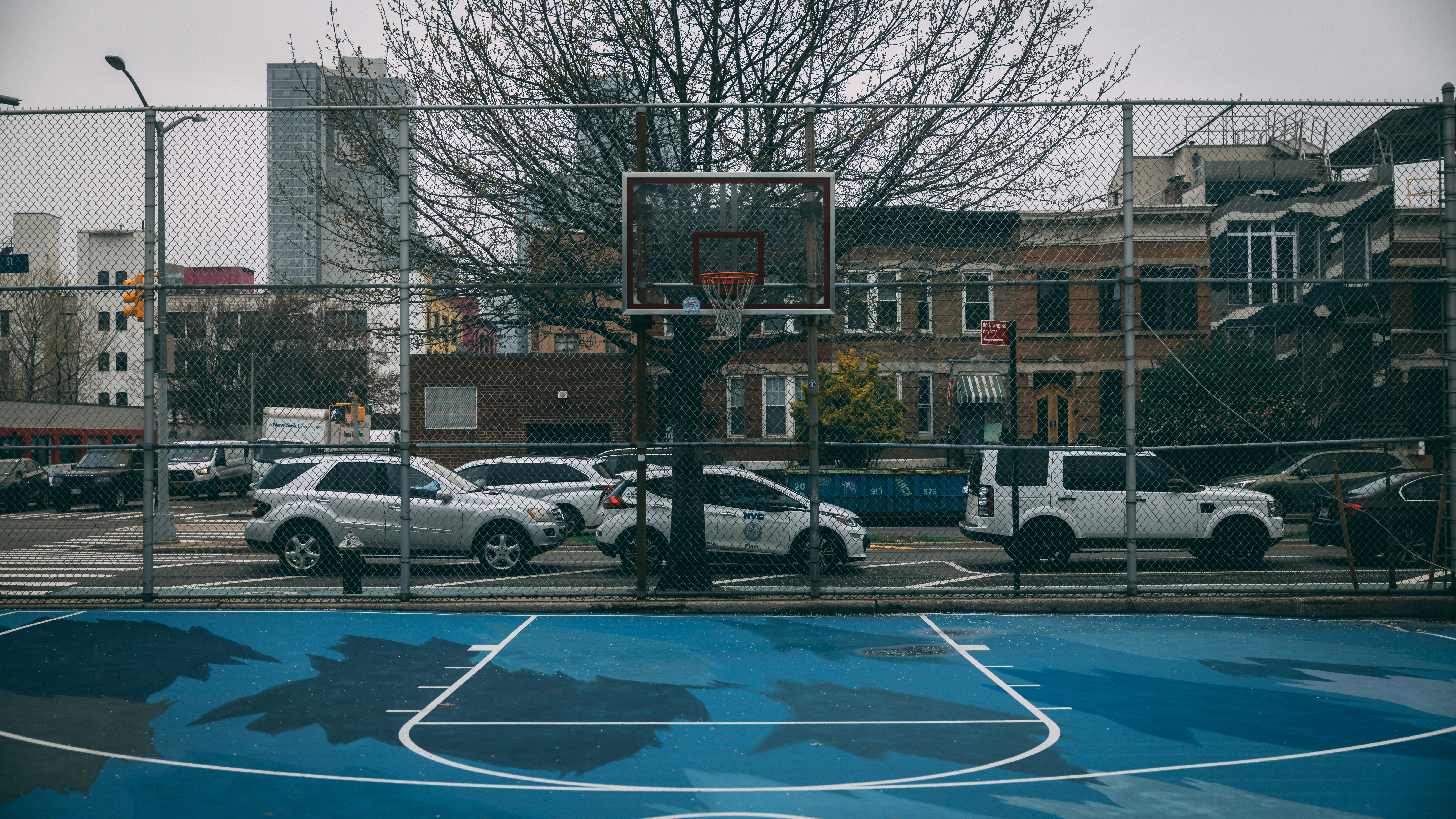 A basketball court with cars parked on it photo – Free Nueva york Image ...