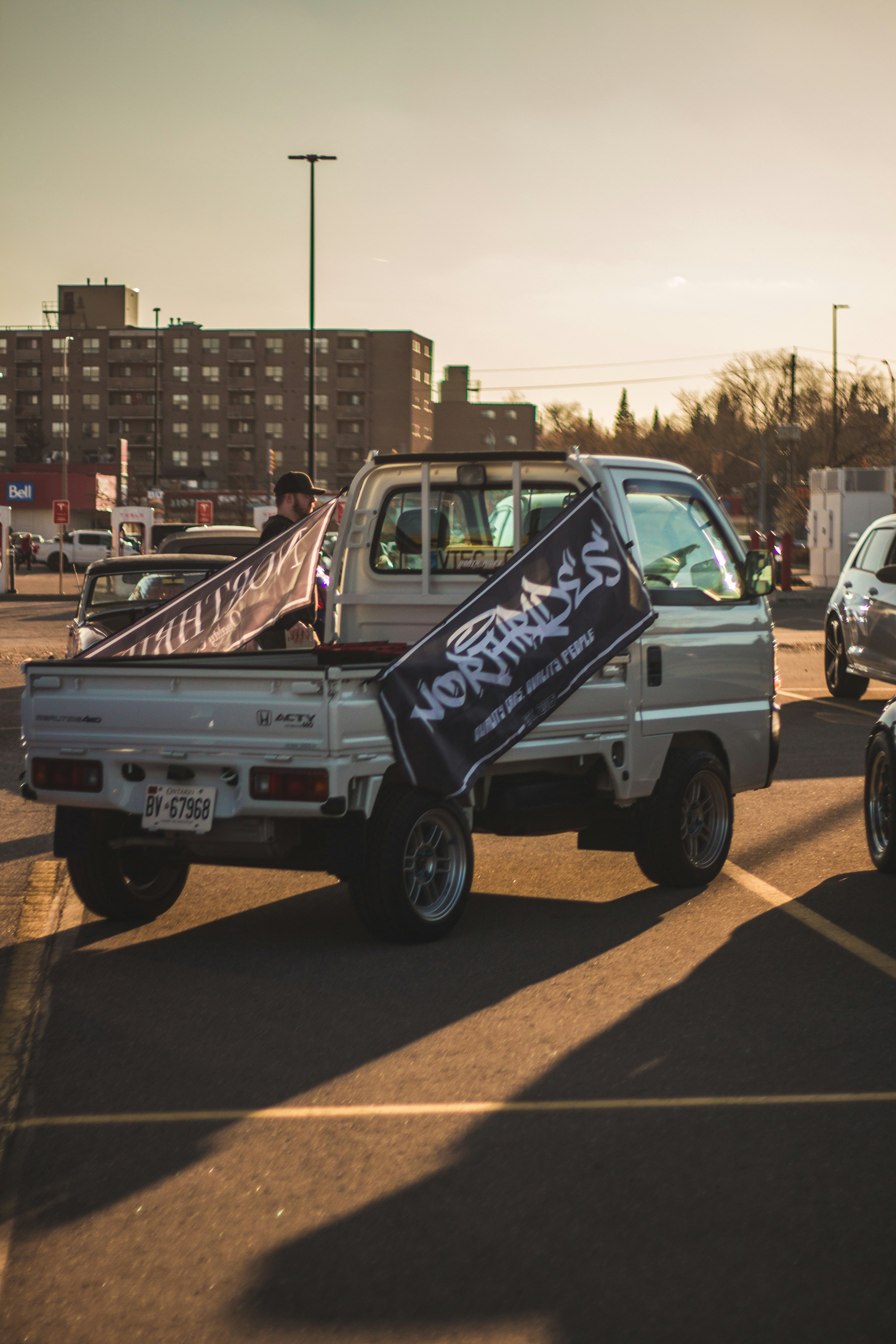 Flagged Pickup in a Parking Lot: A Quiet Moment of Motion