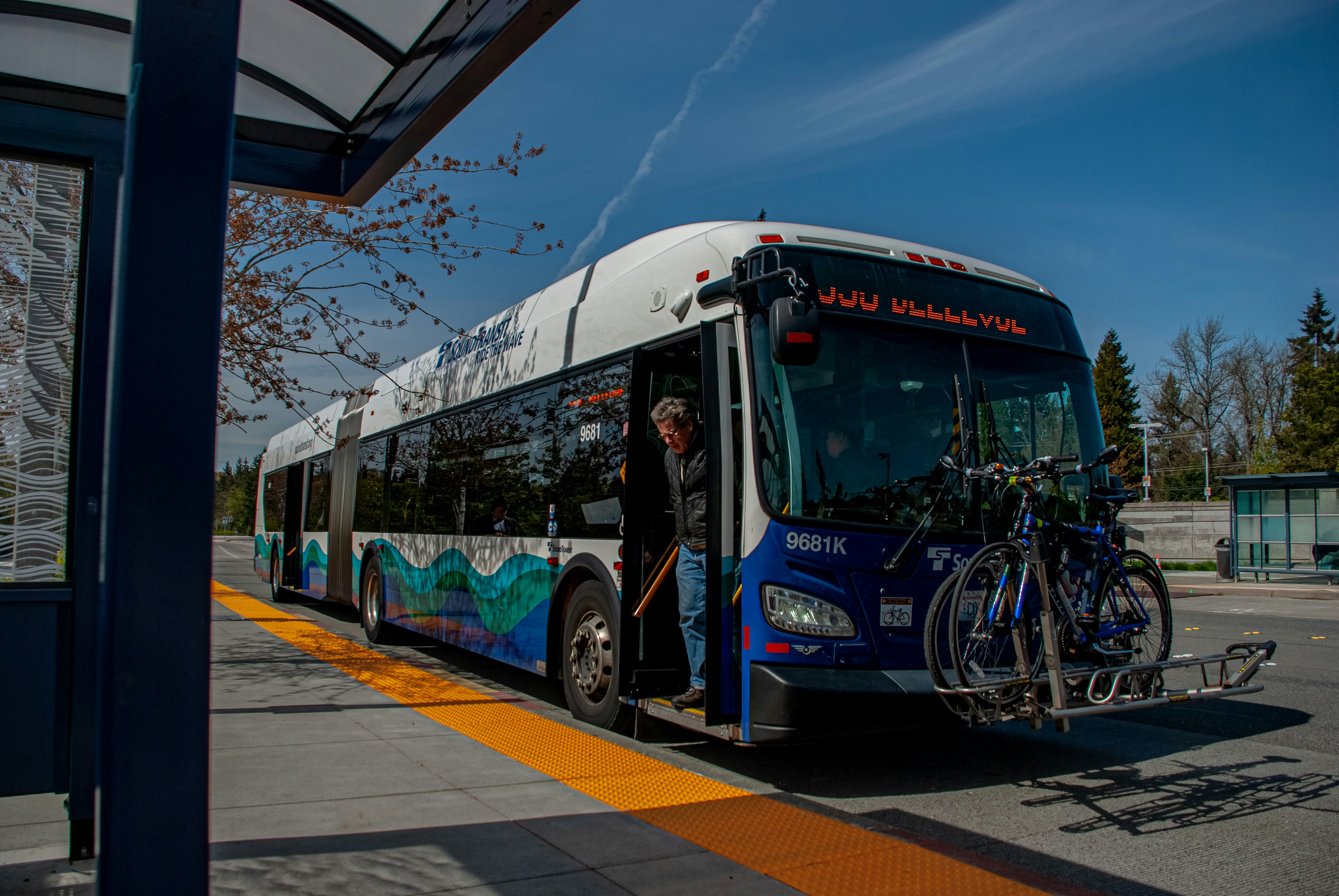 A bus with a bike attached to the front of it photo – Free Bus Image on ...