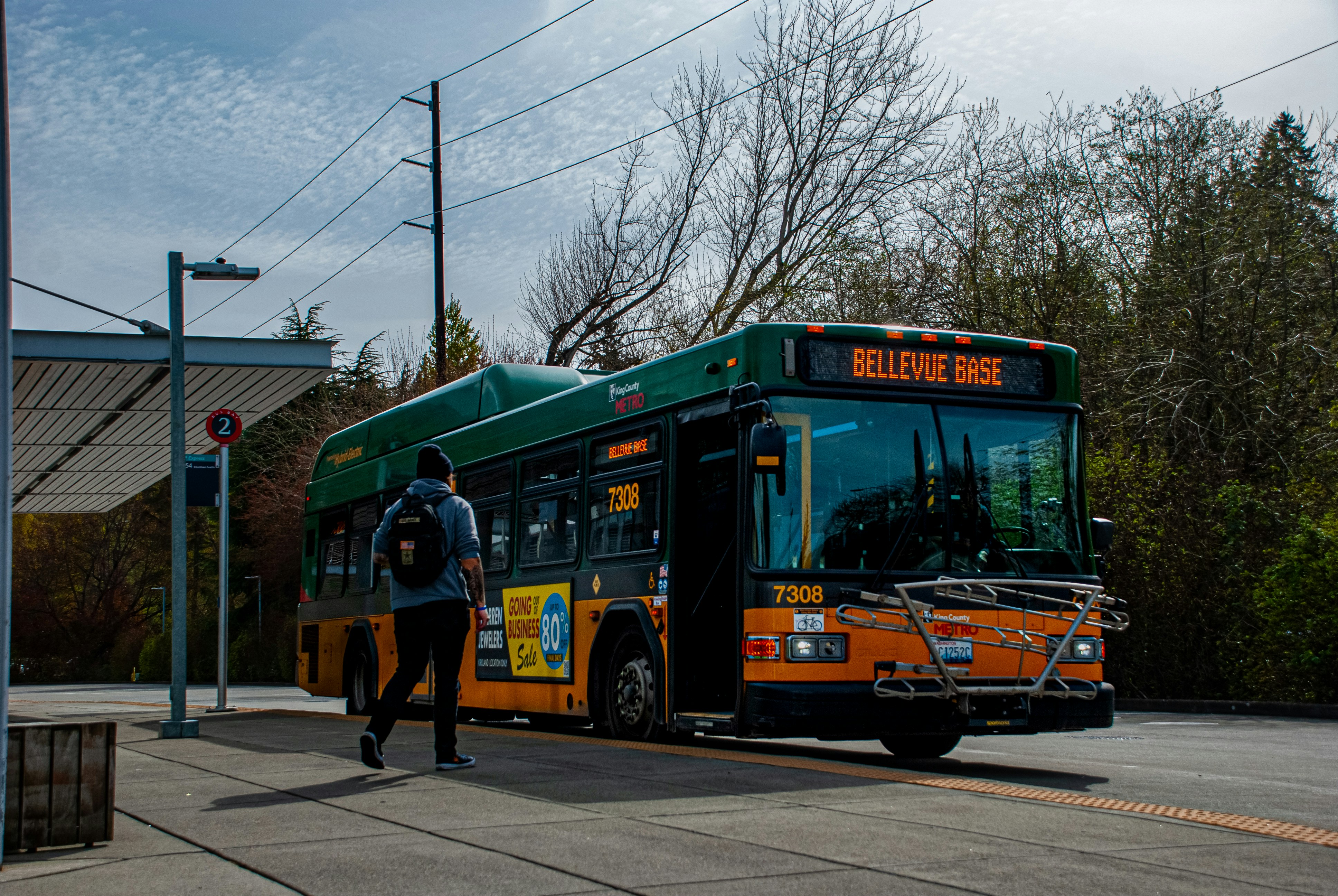 A man standing next to a bus on a street photo – Free Bus Image on Unsplash