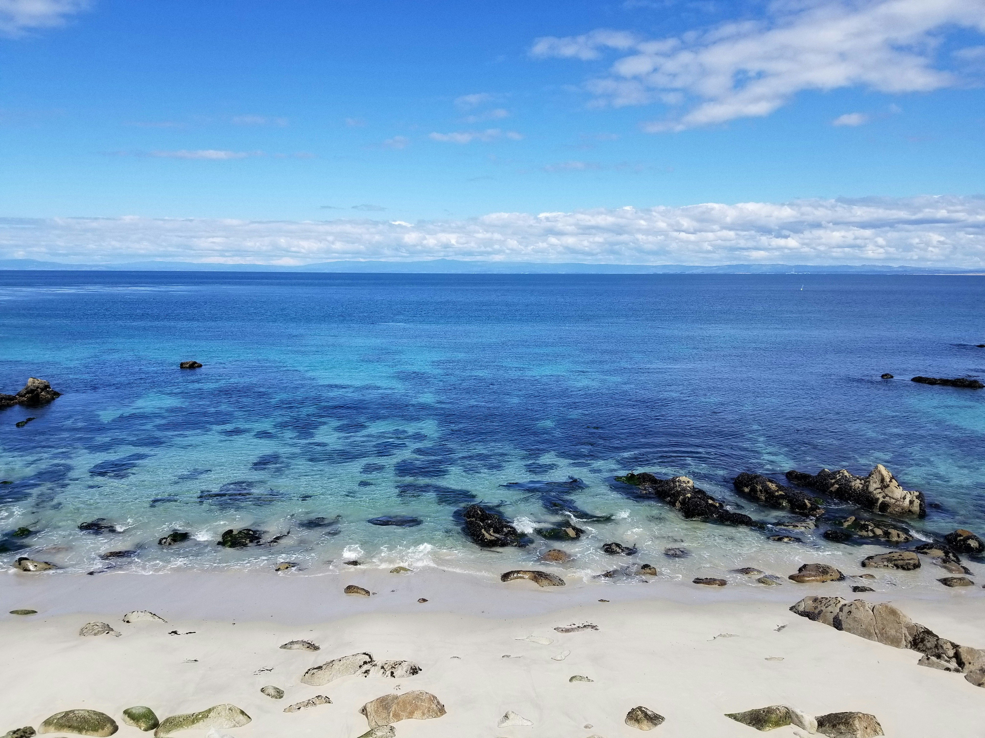 Azure Horizon: Clear Waters Meet Powdered Sand