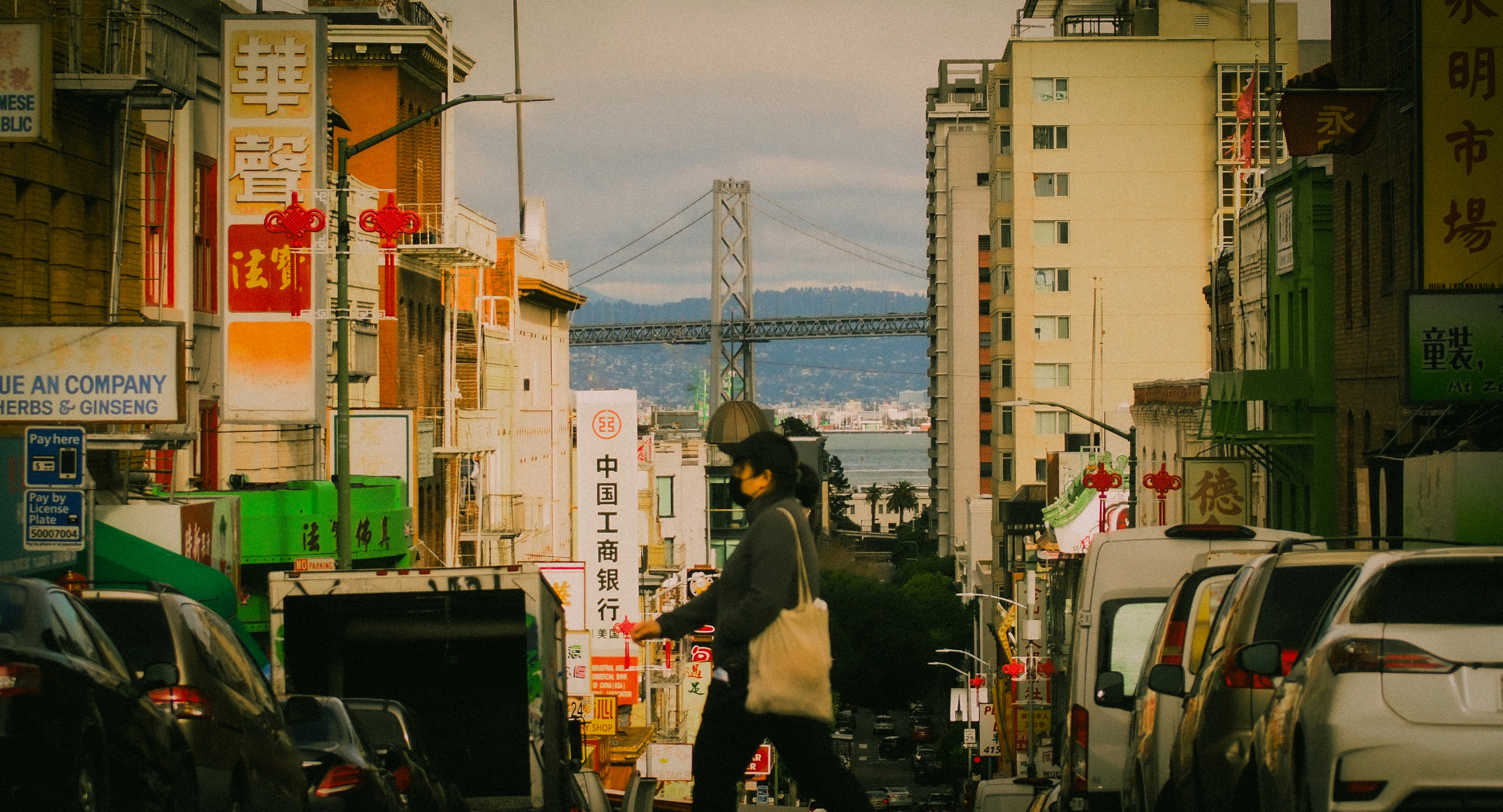 Crossing the Market: A Street-Level View Toward the Distant Harbor and Bridge