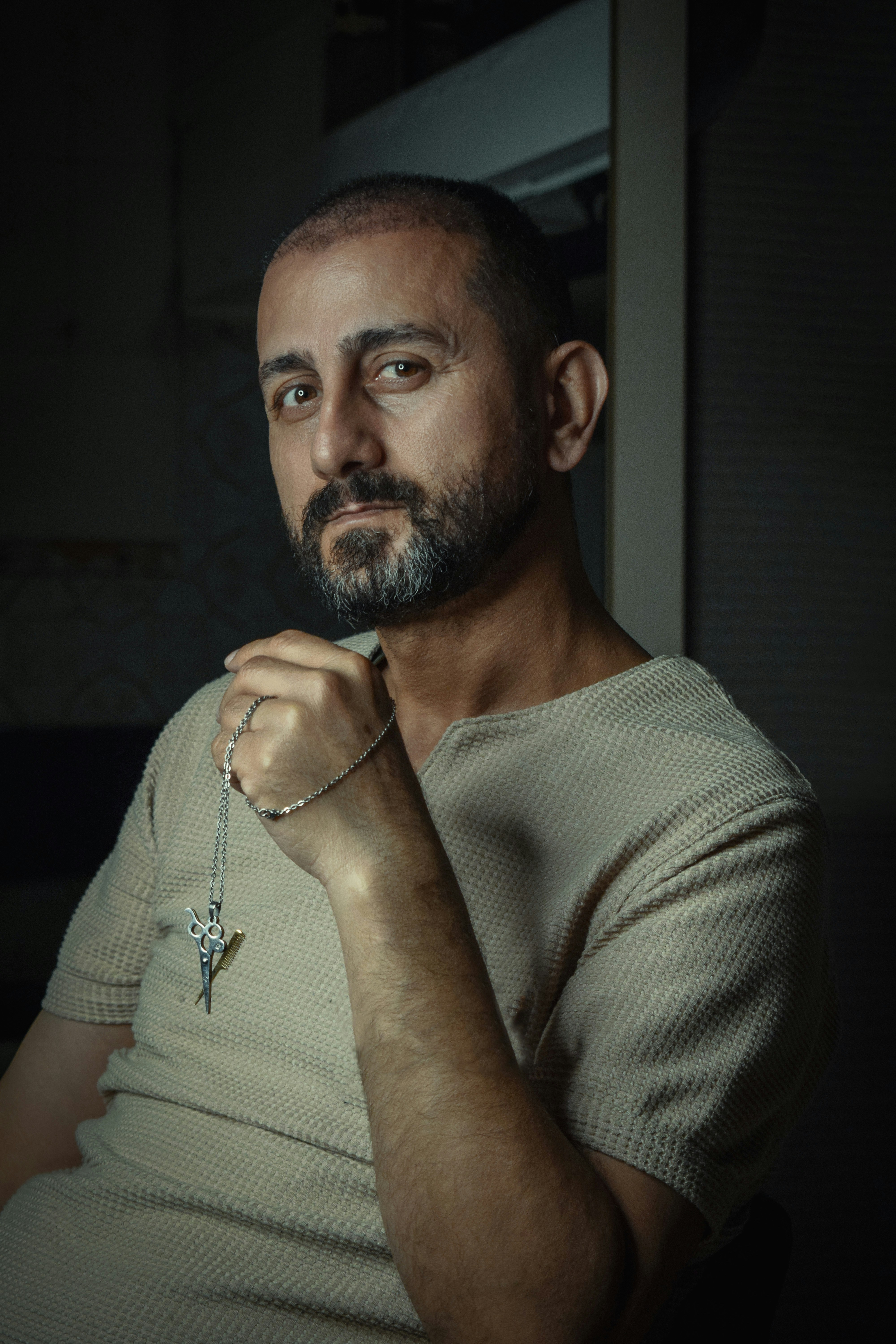 Quiet Confidence: A portrait of steel-gray eyes and a delicate chain