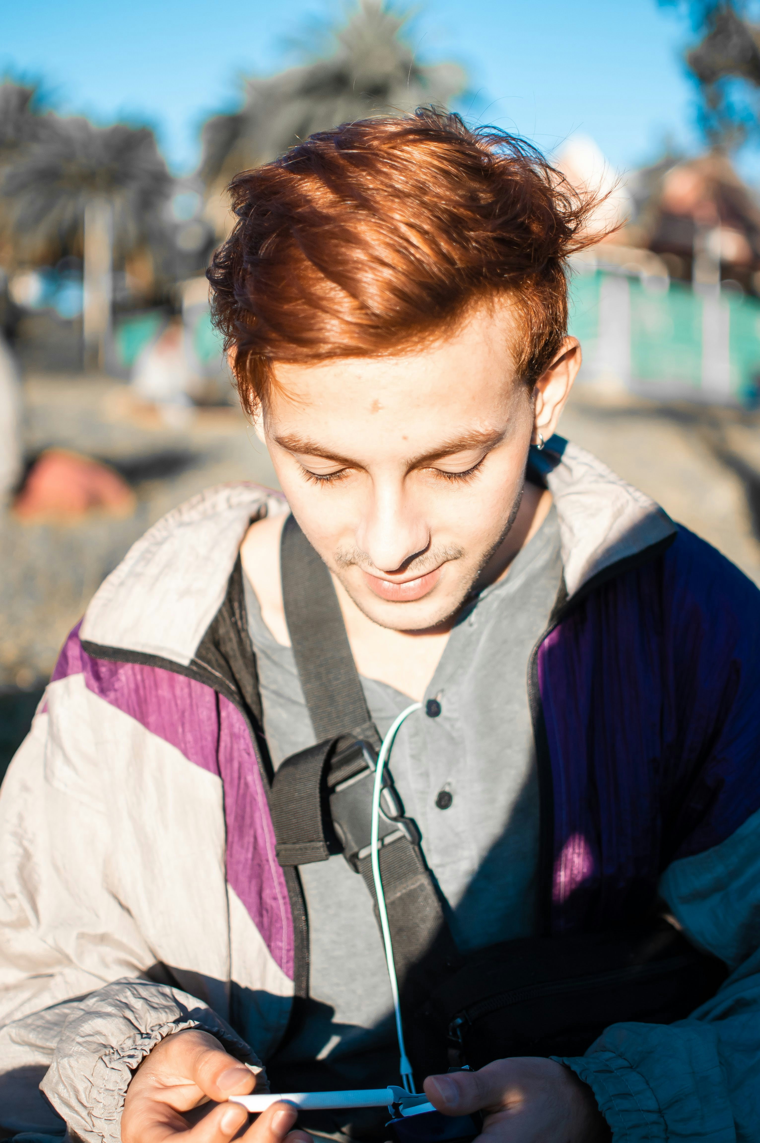 A young man looking at his cell phone photo – Free Portrait Image on ...