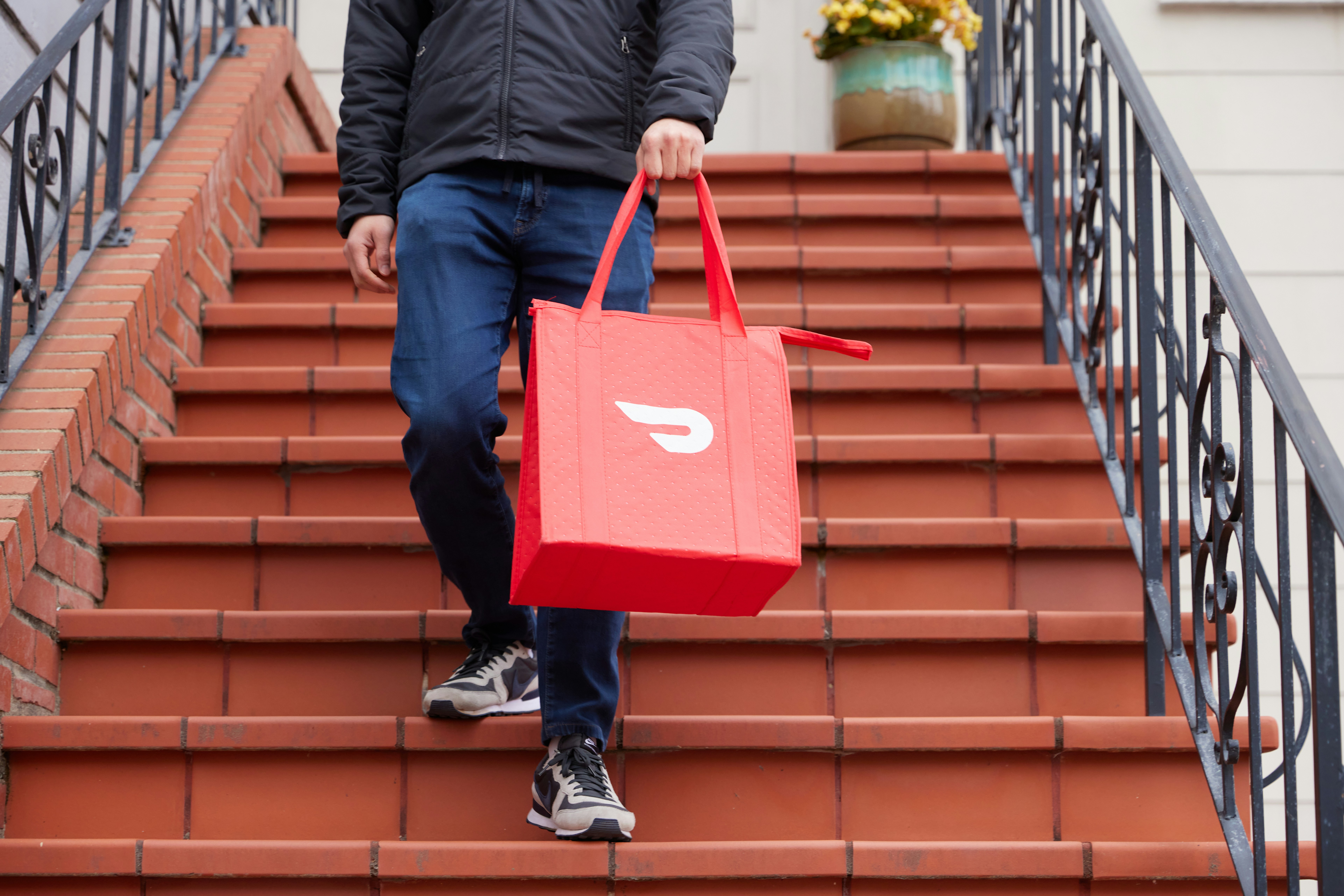 Male walking down the steps with DoorDash bag photo – Free Accessories ...