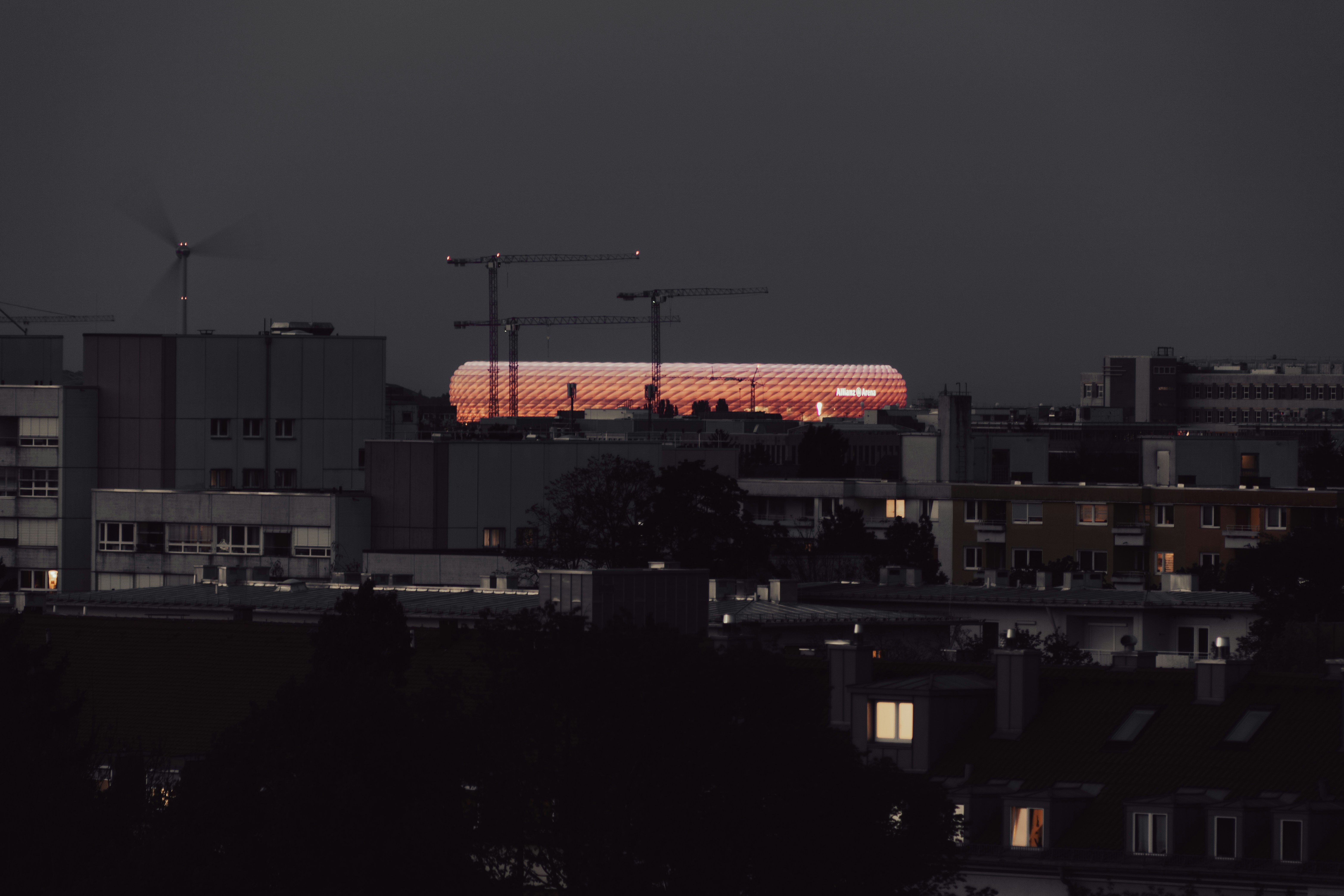 Ember Arc Over the Skyline: A glowing rooftop silhouette crowns the dusk-lit city
