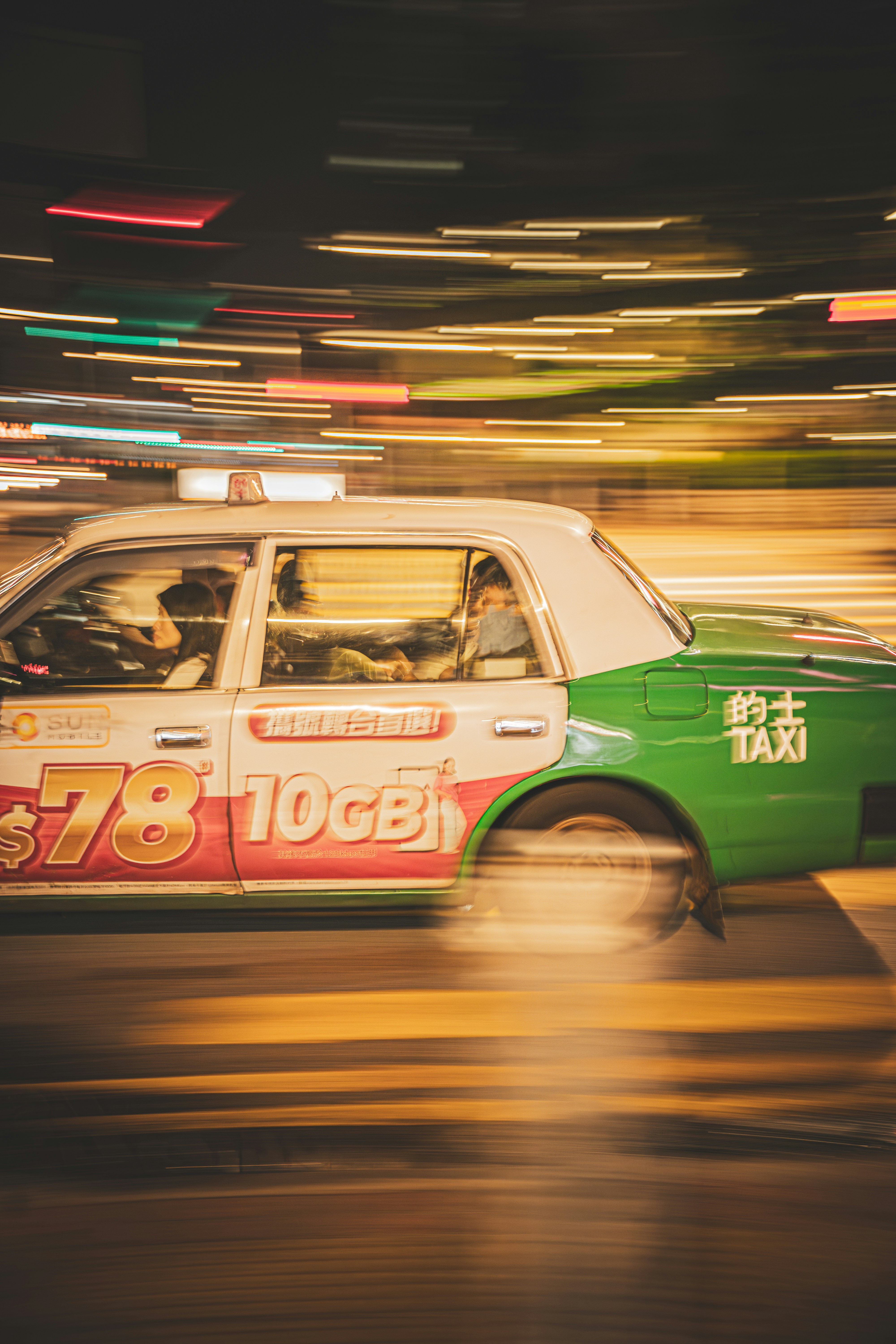 A green and white taxi driving down a street photo – Free Hong kong ...