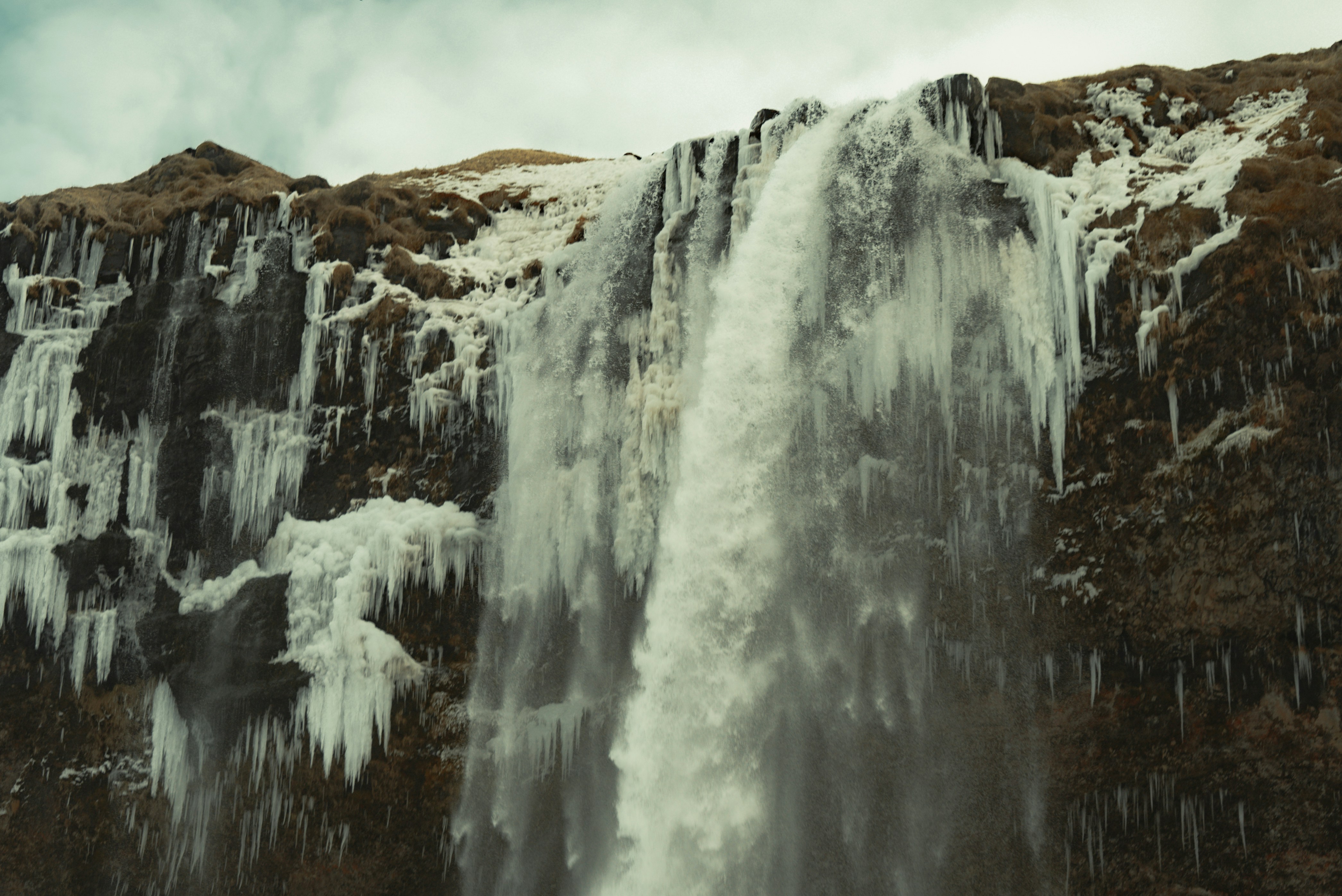 A very tall waterfall with lots of ice on it photo – Free Green Image ...