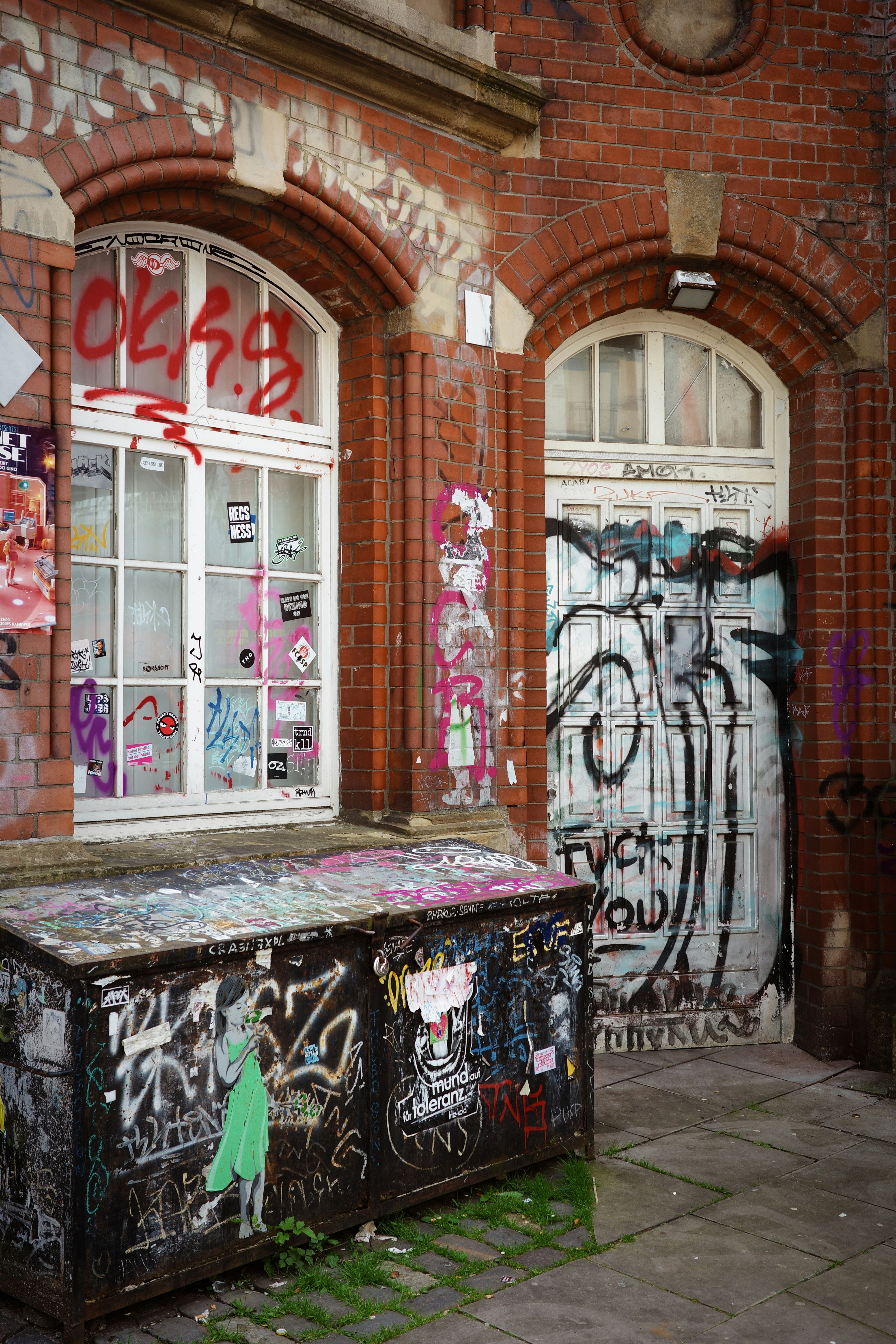 Brick Archway Graffiti Gate: A Textured Urban Portrait