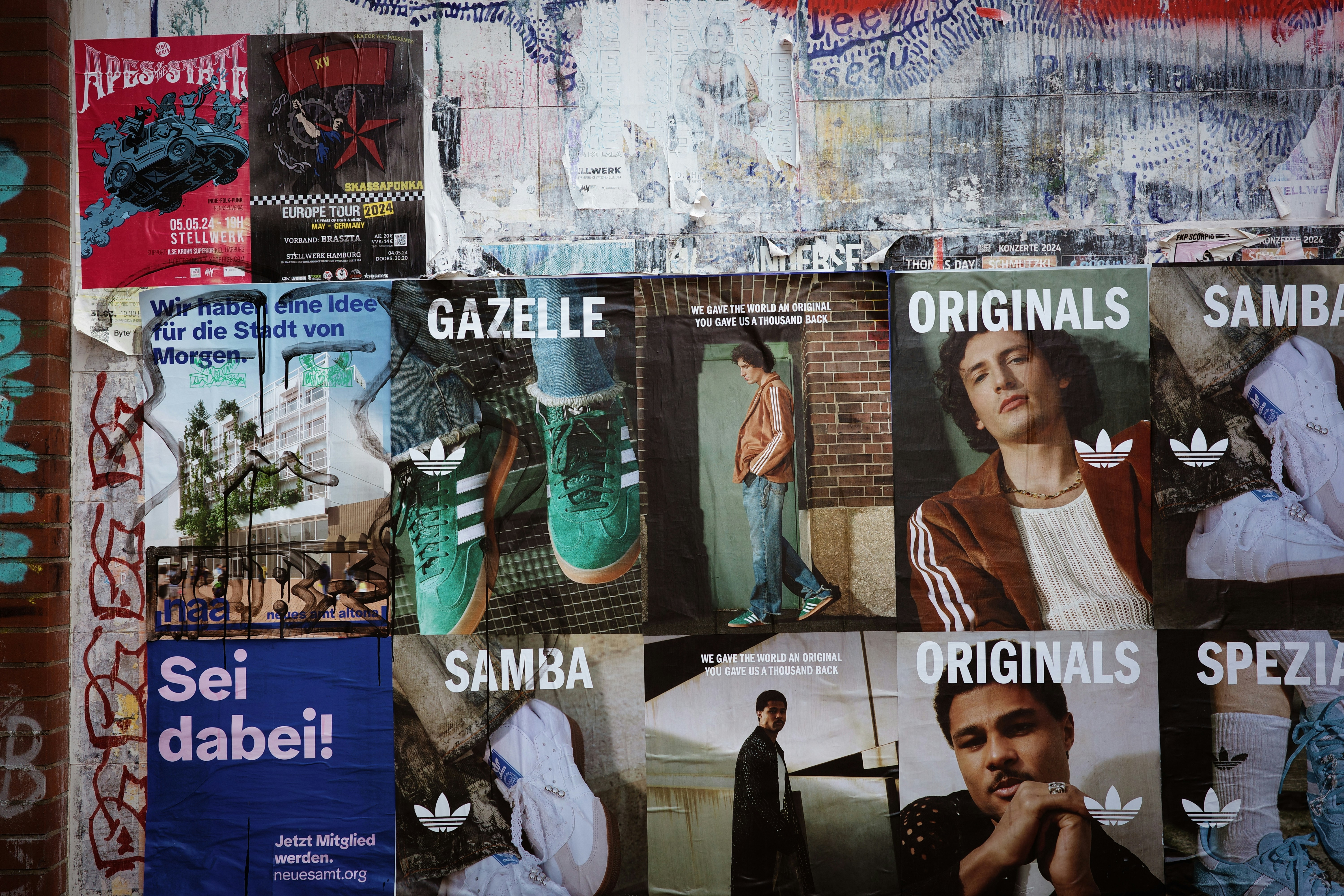a collage of posters on the wall of a building