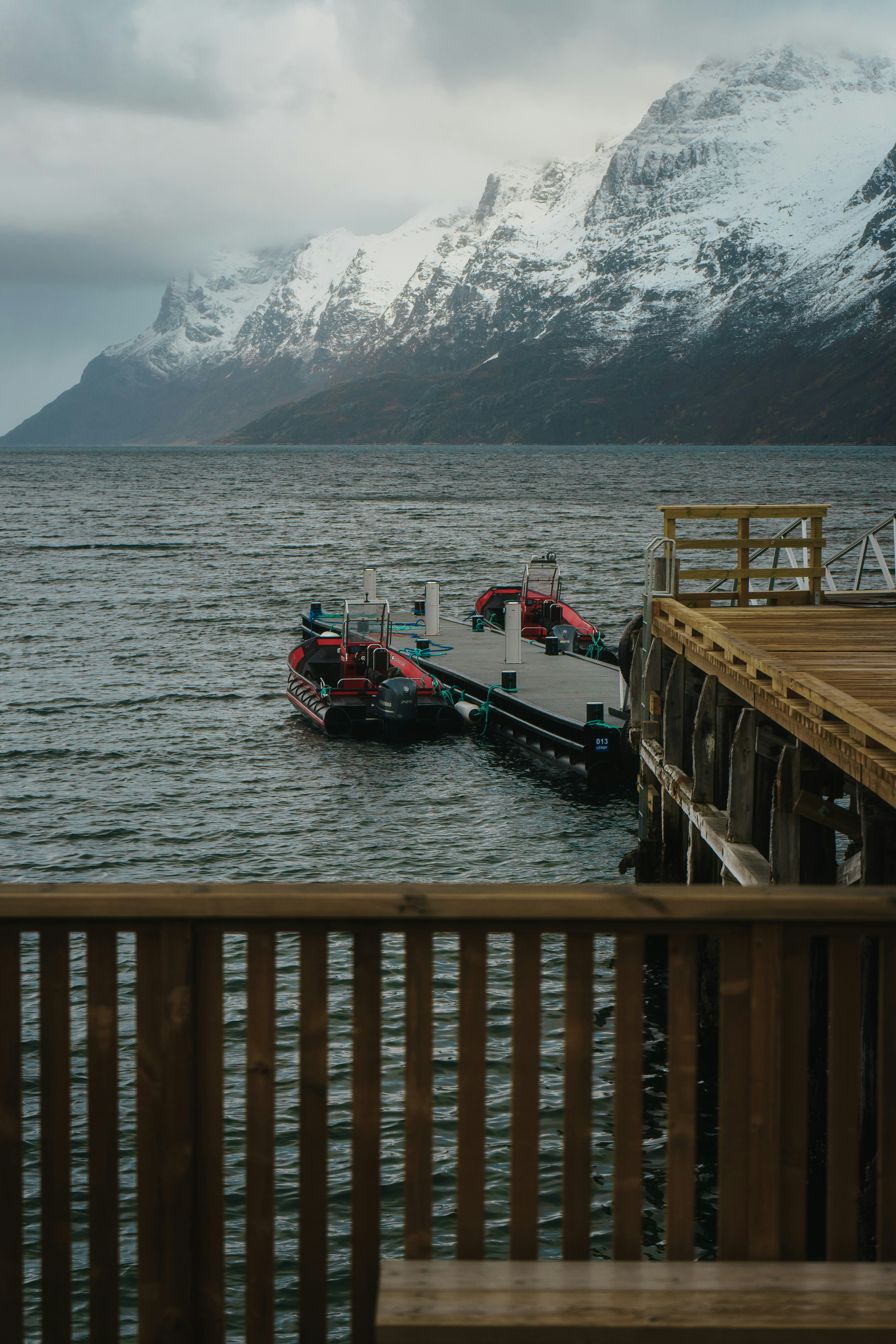 A small dock extending out from the shop Bryggejentene AS in Ersfjordbotn, Norway