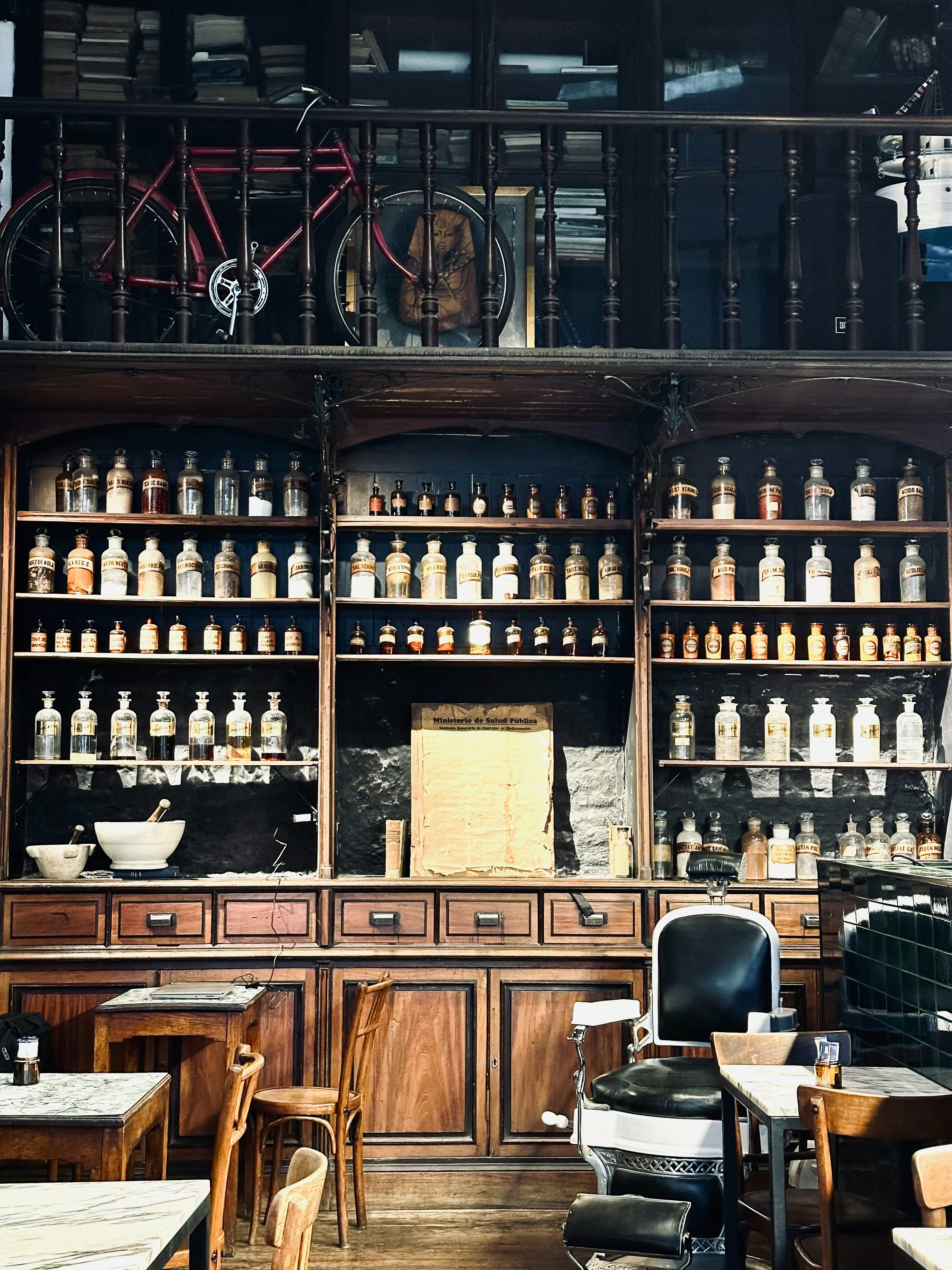 The Ledger Behind the Bottles: A Vintage Bar Scene with a Bicycle on Display