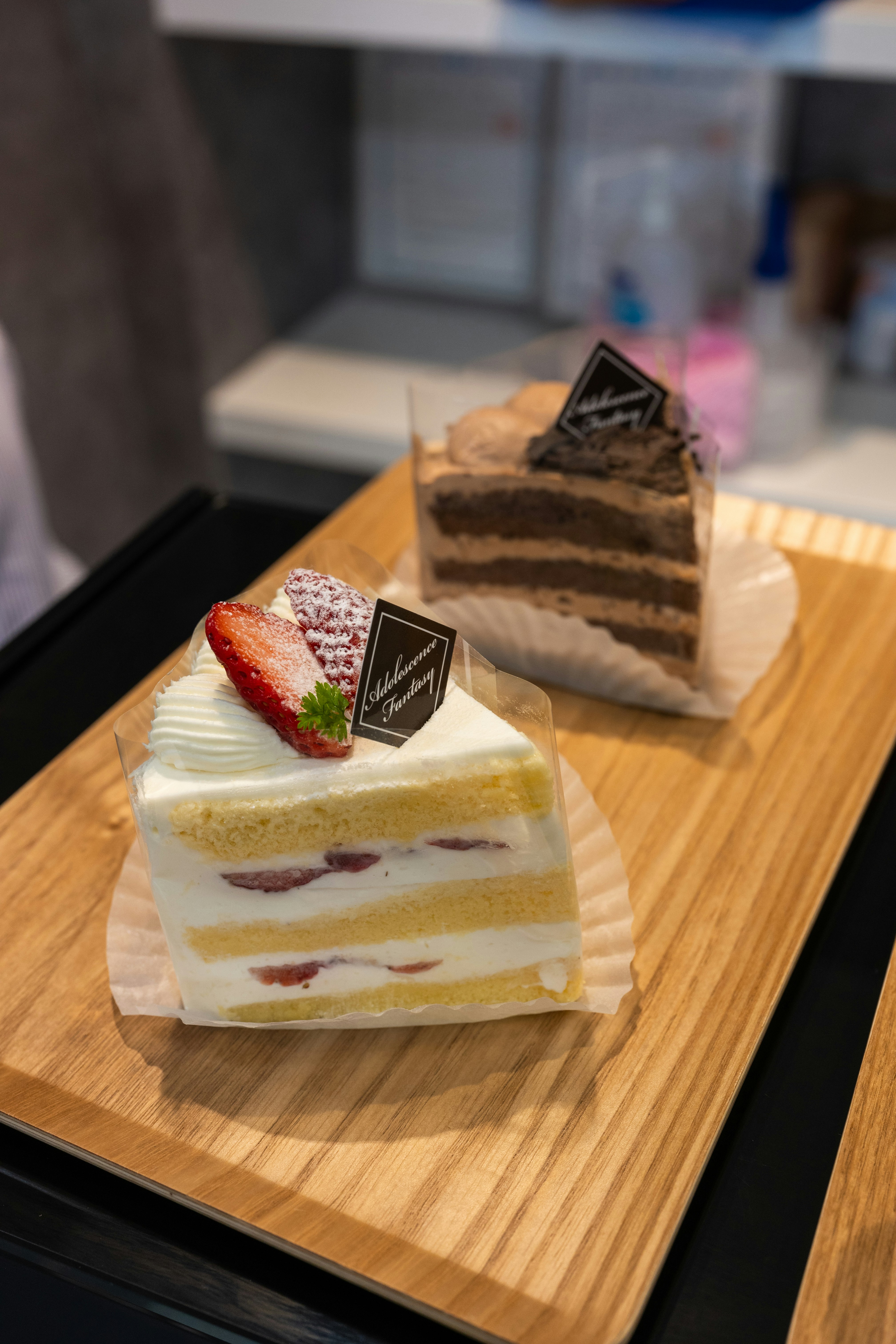Strawberry-Striped Vanilla Layer Cake Anchored in a Bakery Display
